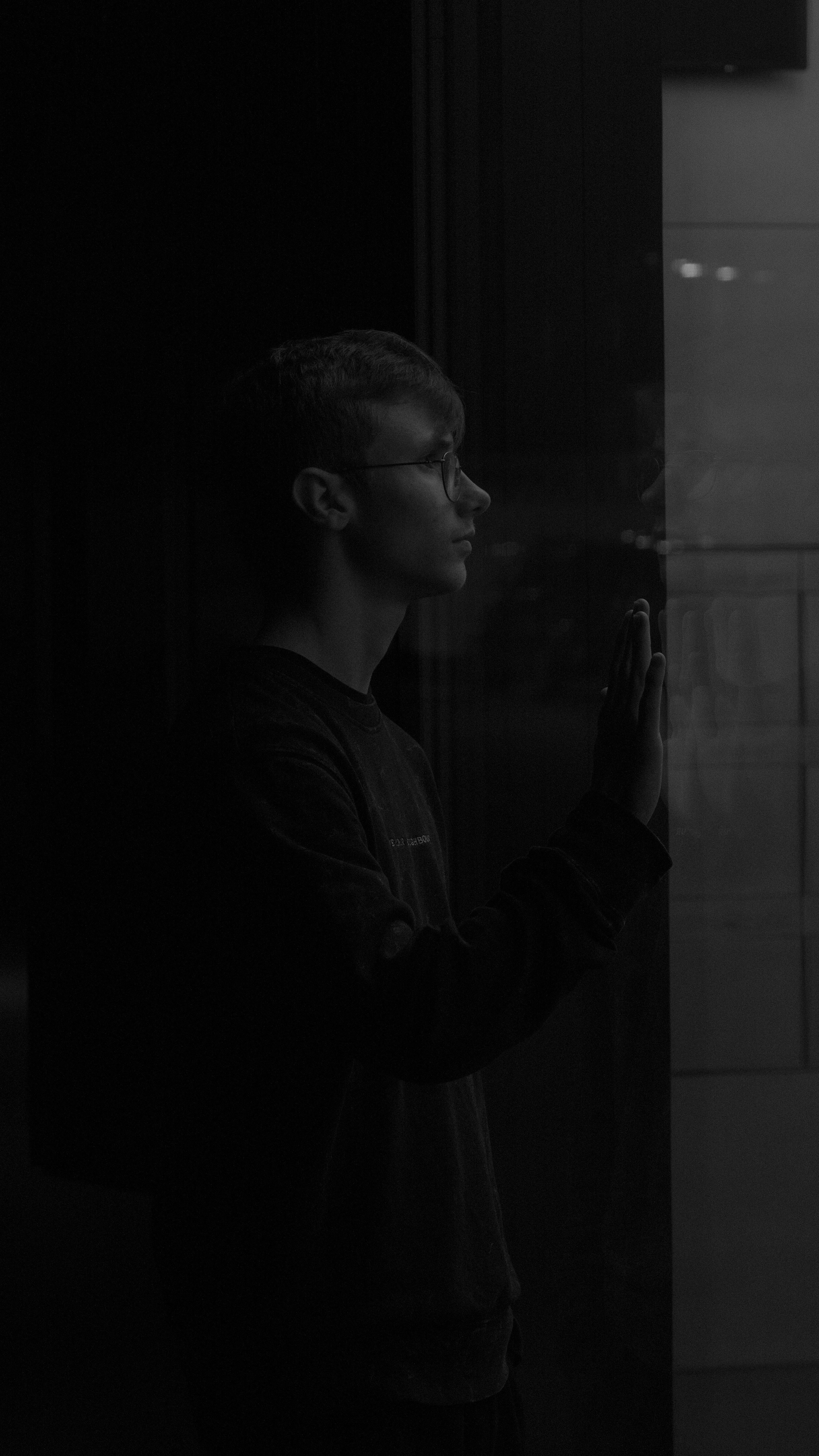 Profile Against the Glass: A Quiet Night Portrait in Mono