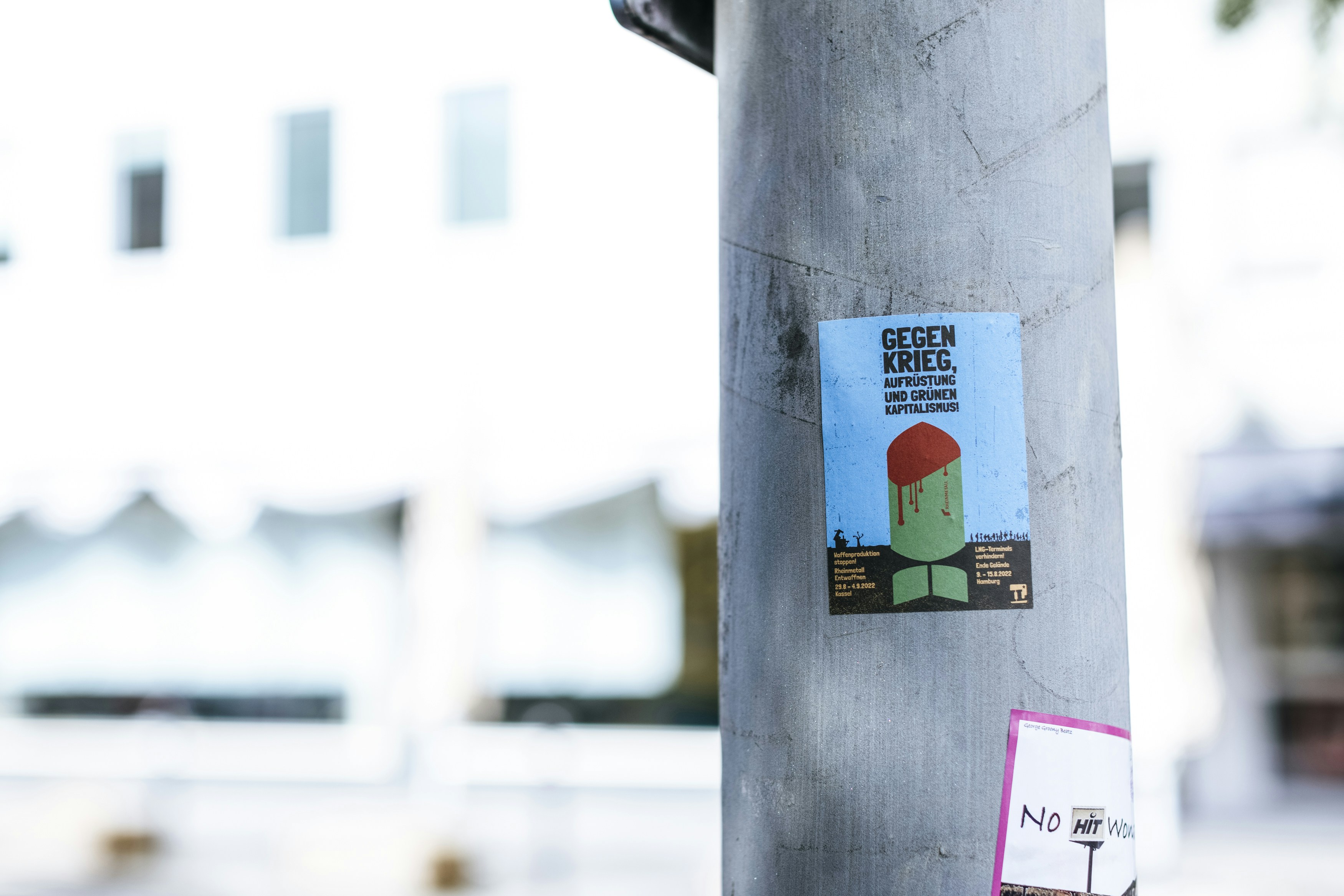 Against war, rearmament and green capitalism! Urban street art political and society protest sticker.