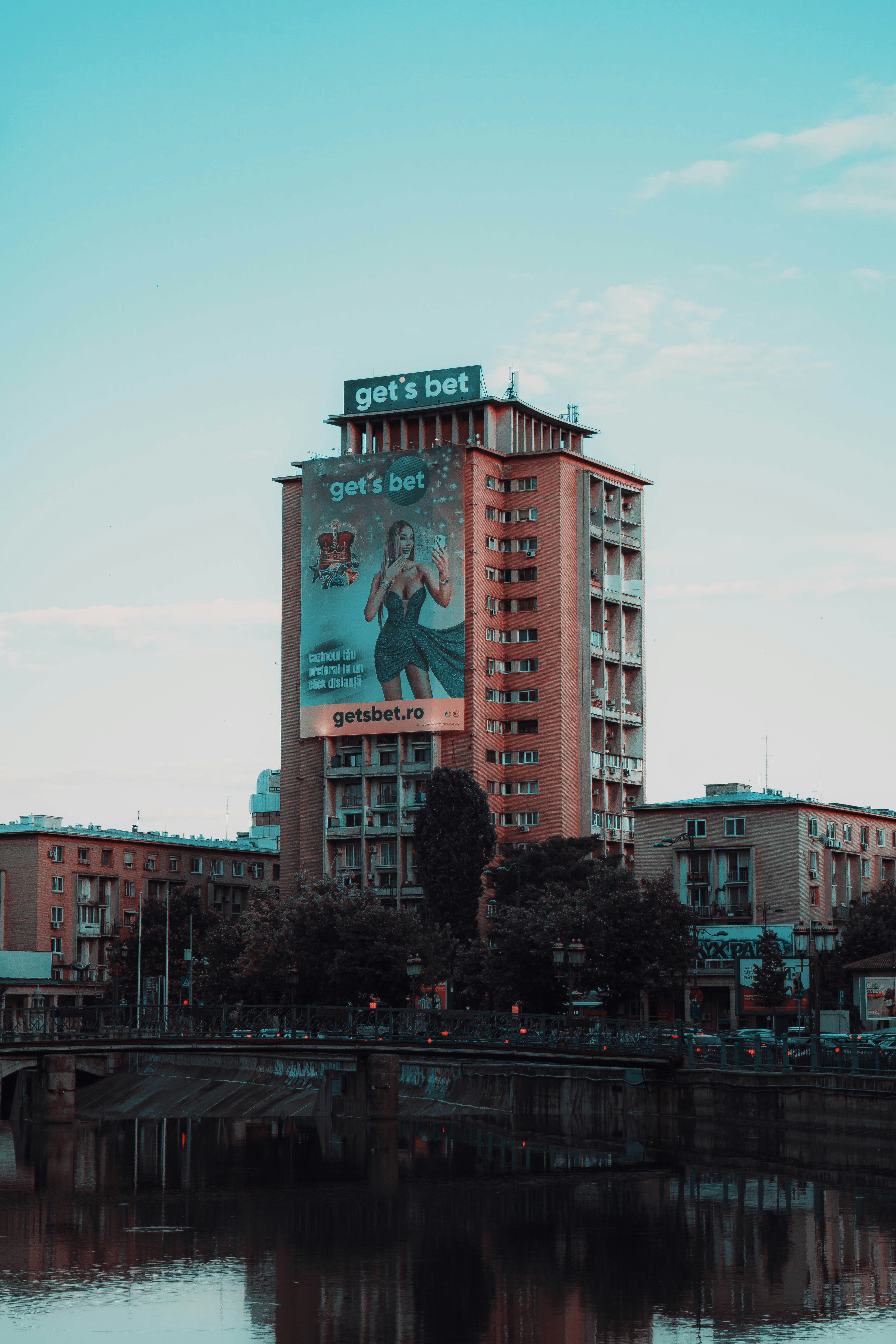 Get's Bet Tower: Brick High-Rise Framed by a Riverside Sky
