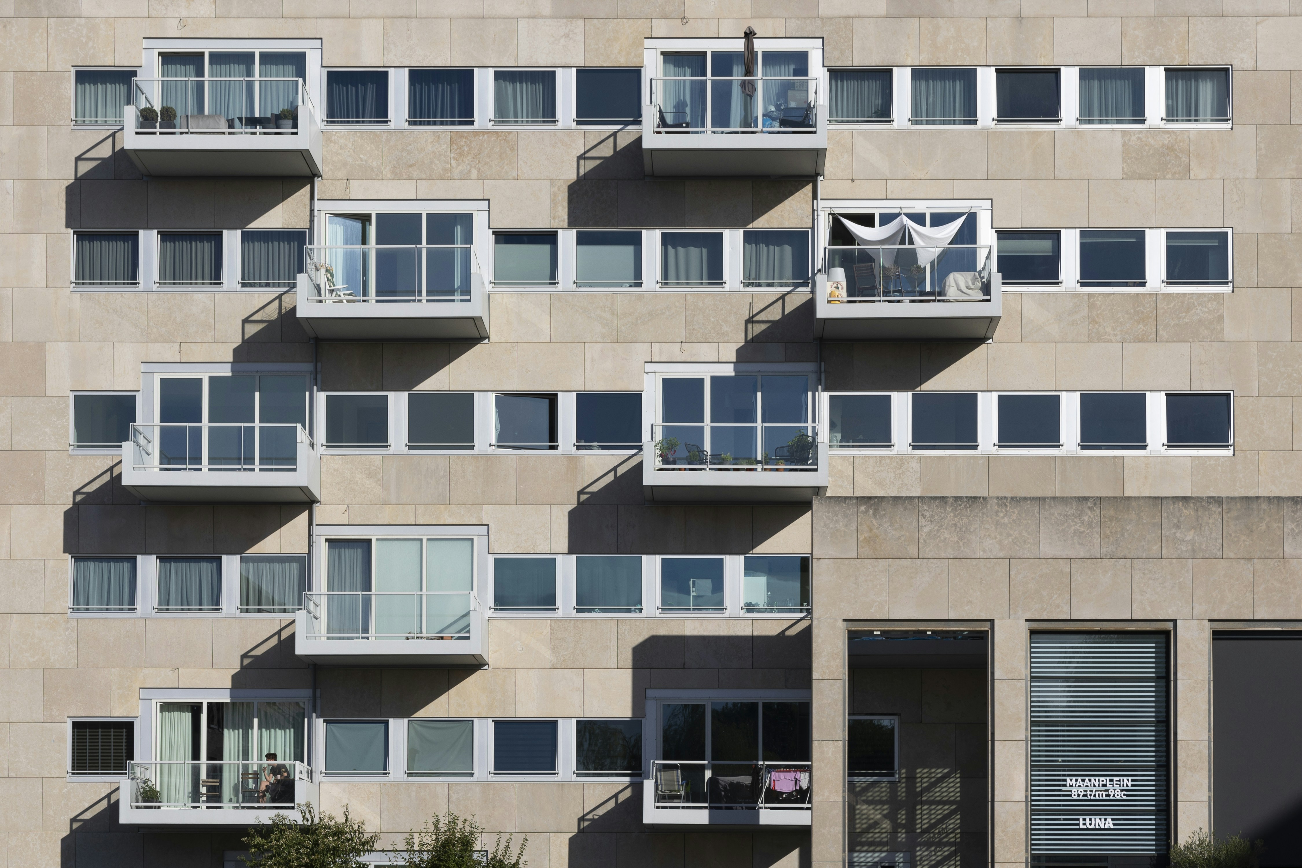 Balconies in Tandem: Urban Facade with Recessed Glass Boxes