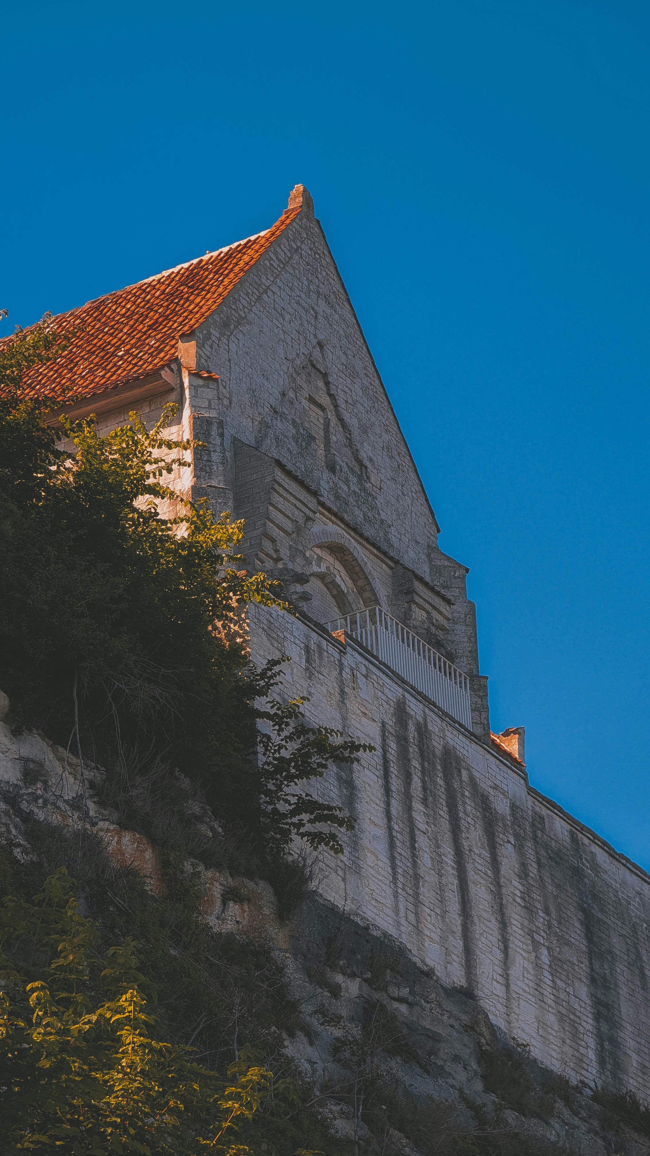 Clifftop Sanctuary: Stone Church Under a Cerulean Crest