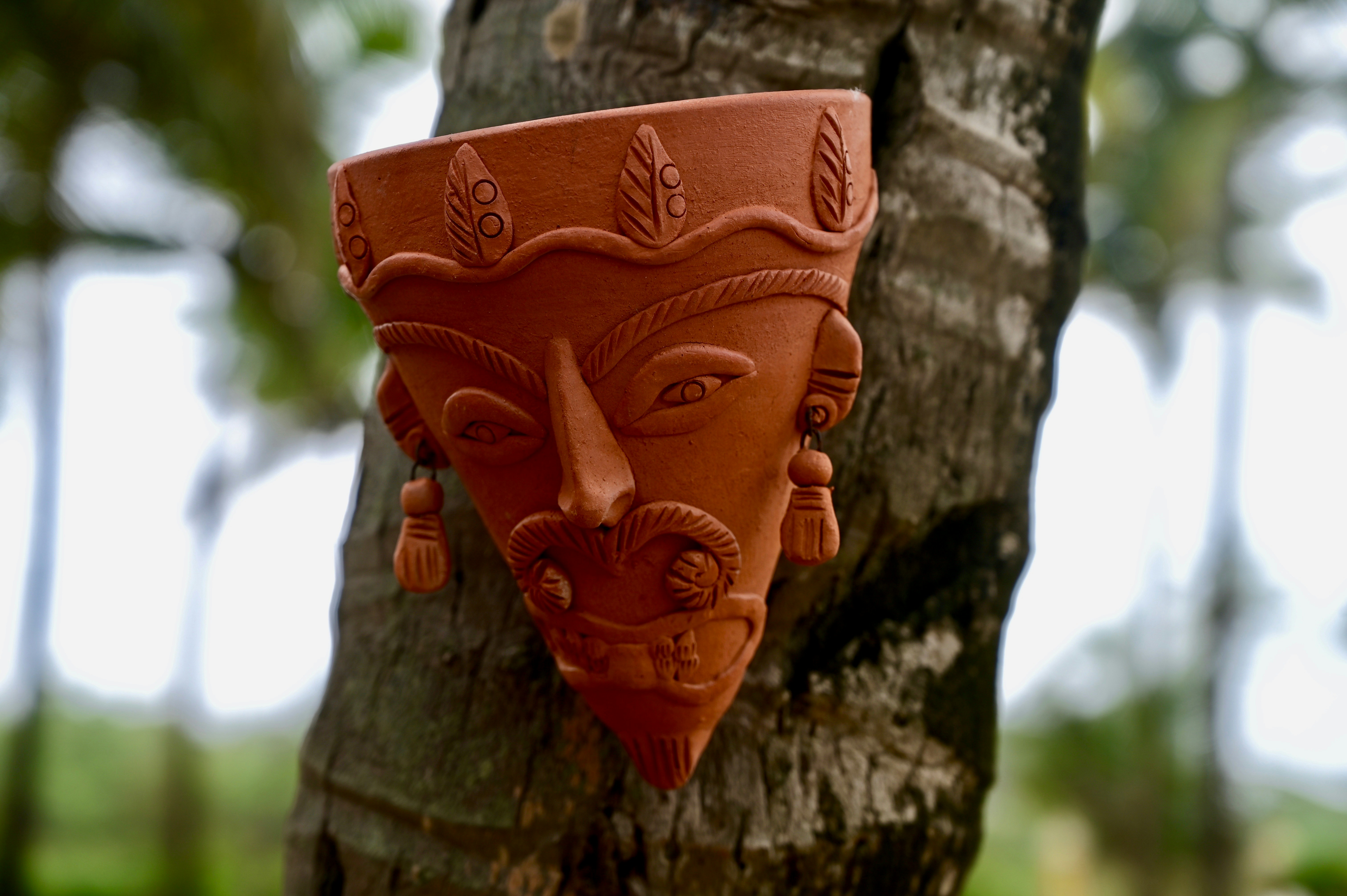 Terracotta Mask Speaks from the Trunk