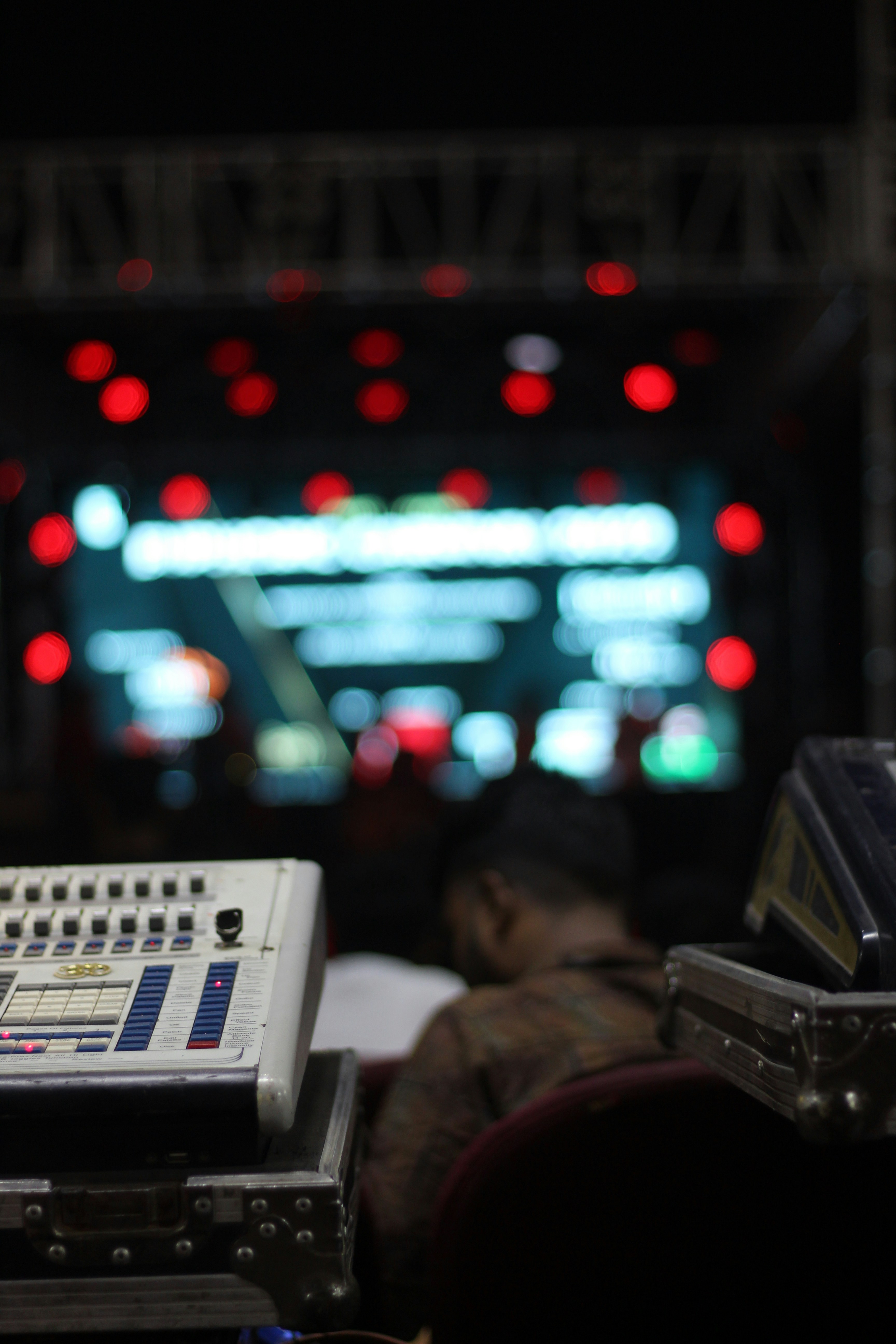 Backstage Control Deck Beneath a Sea of Red Bokeh