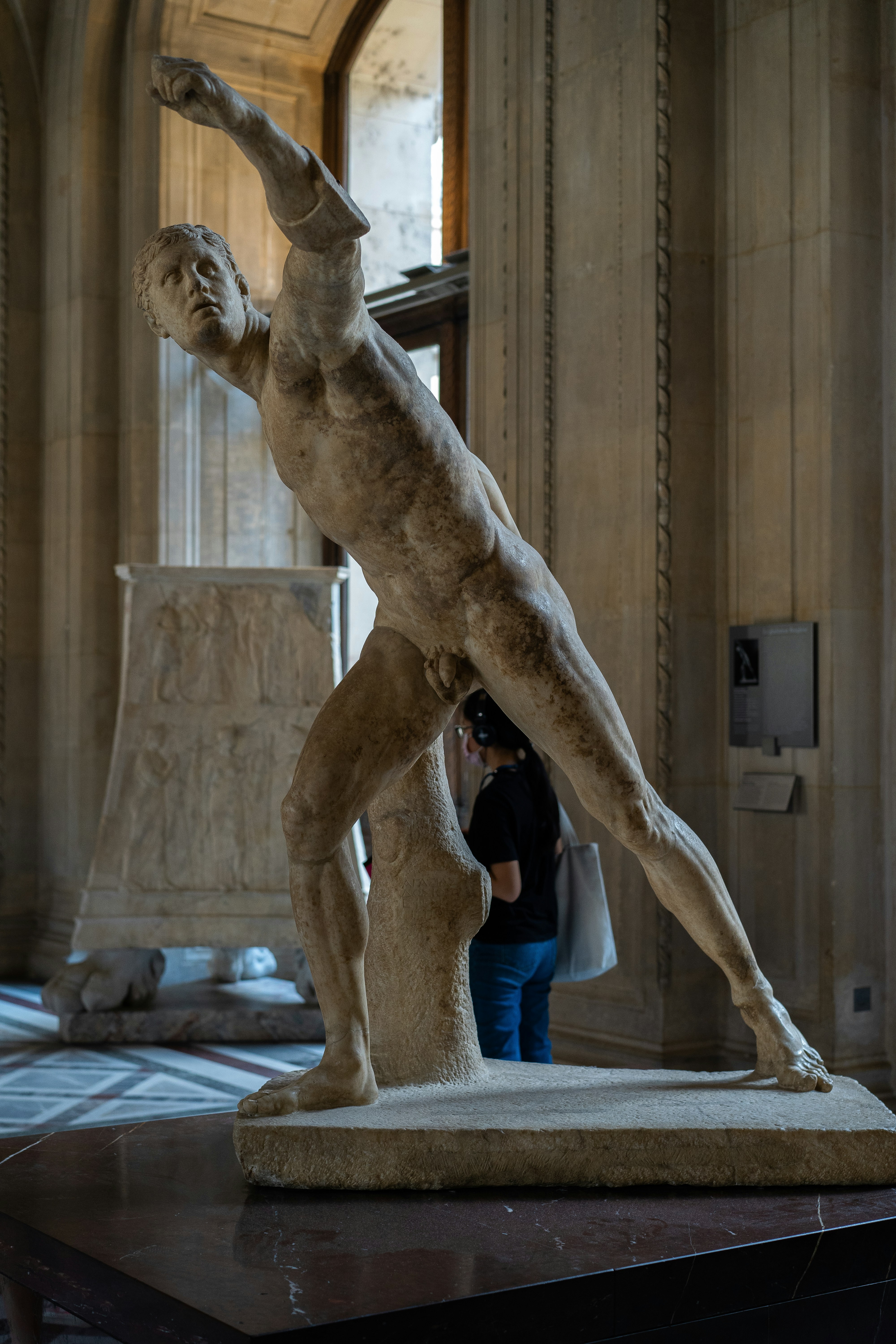 a person taking a picture of a large statue of a dinosaur