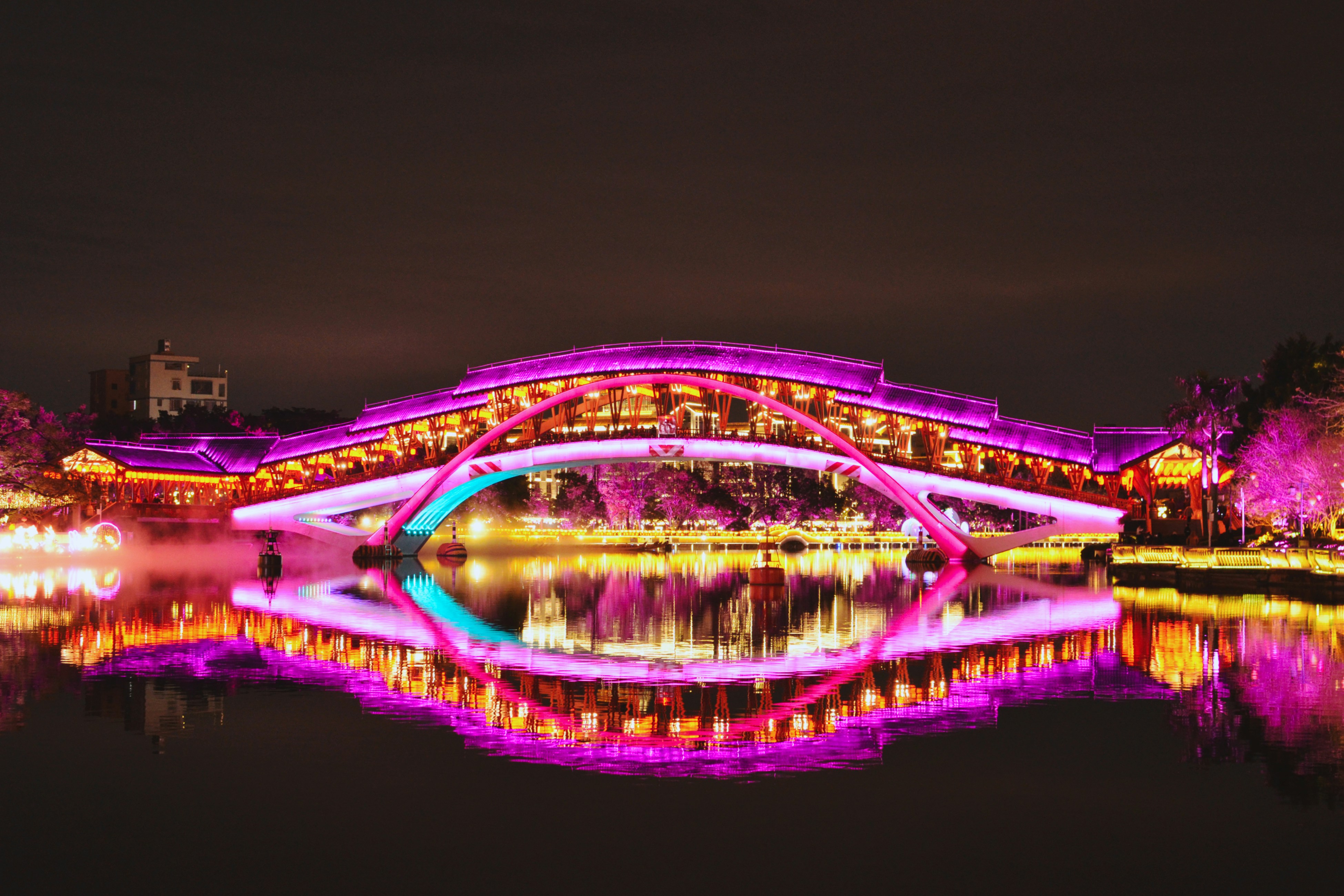 Neon Arch Reflections: A Nighttime Bridge in Violet Light