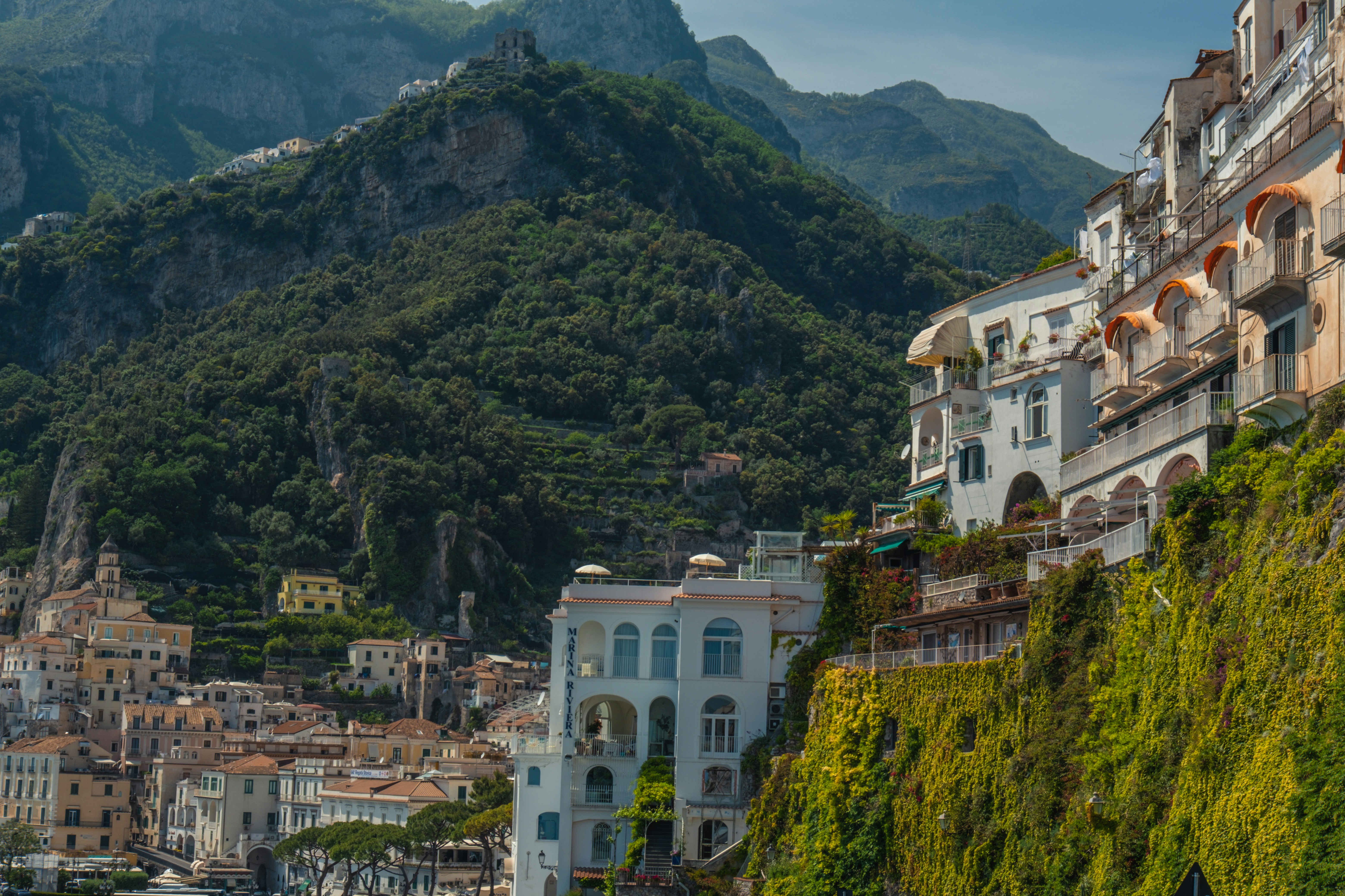 a city with trees and mountains in the backgroundLine Kjær