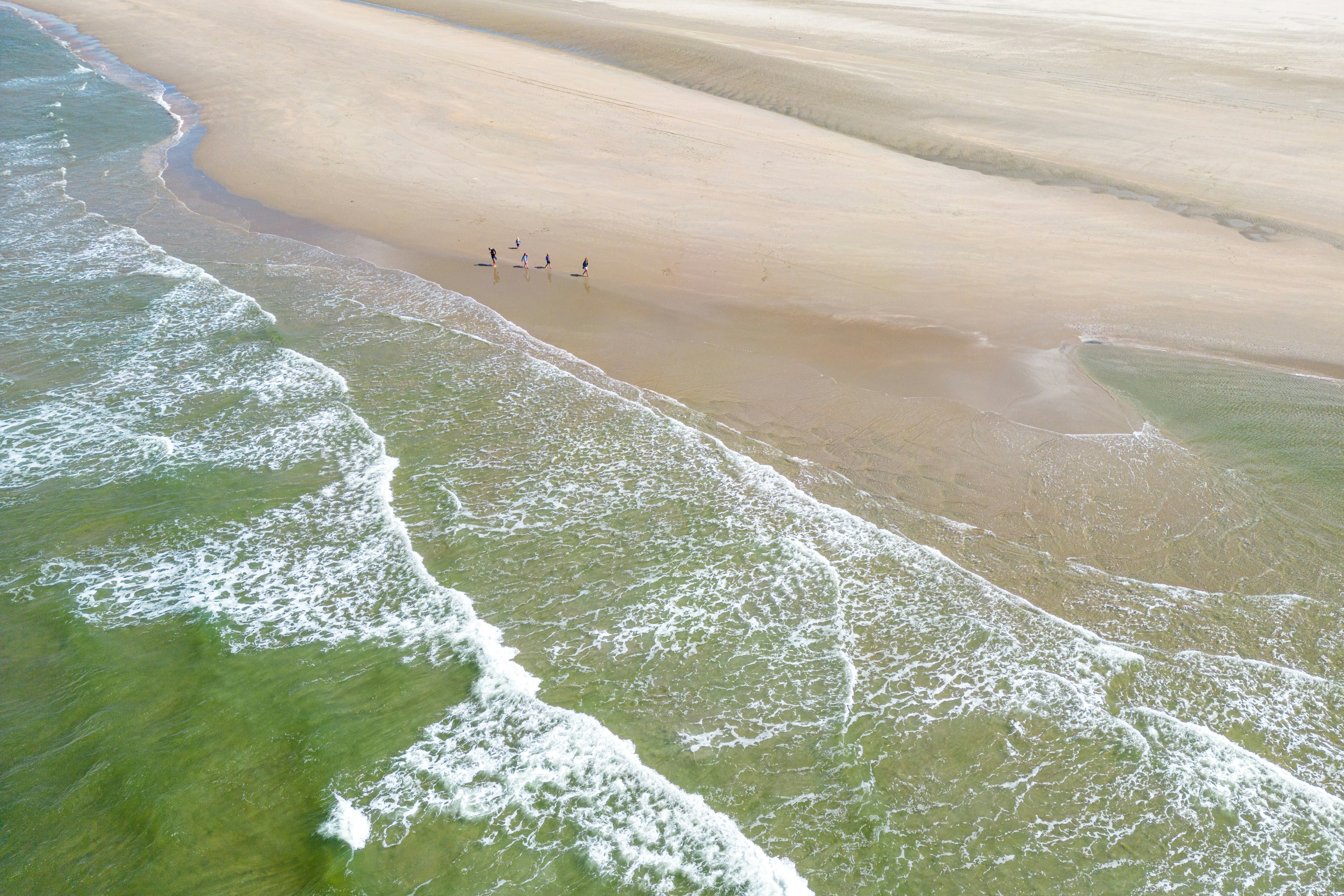 Aerial Whisper: Gentle Tide Lines on Open Sand