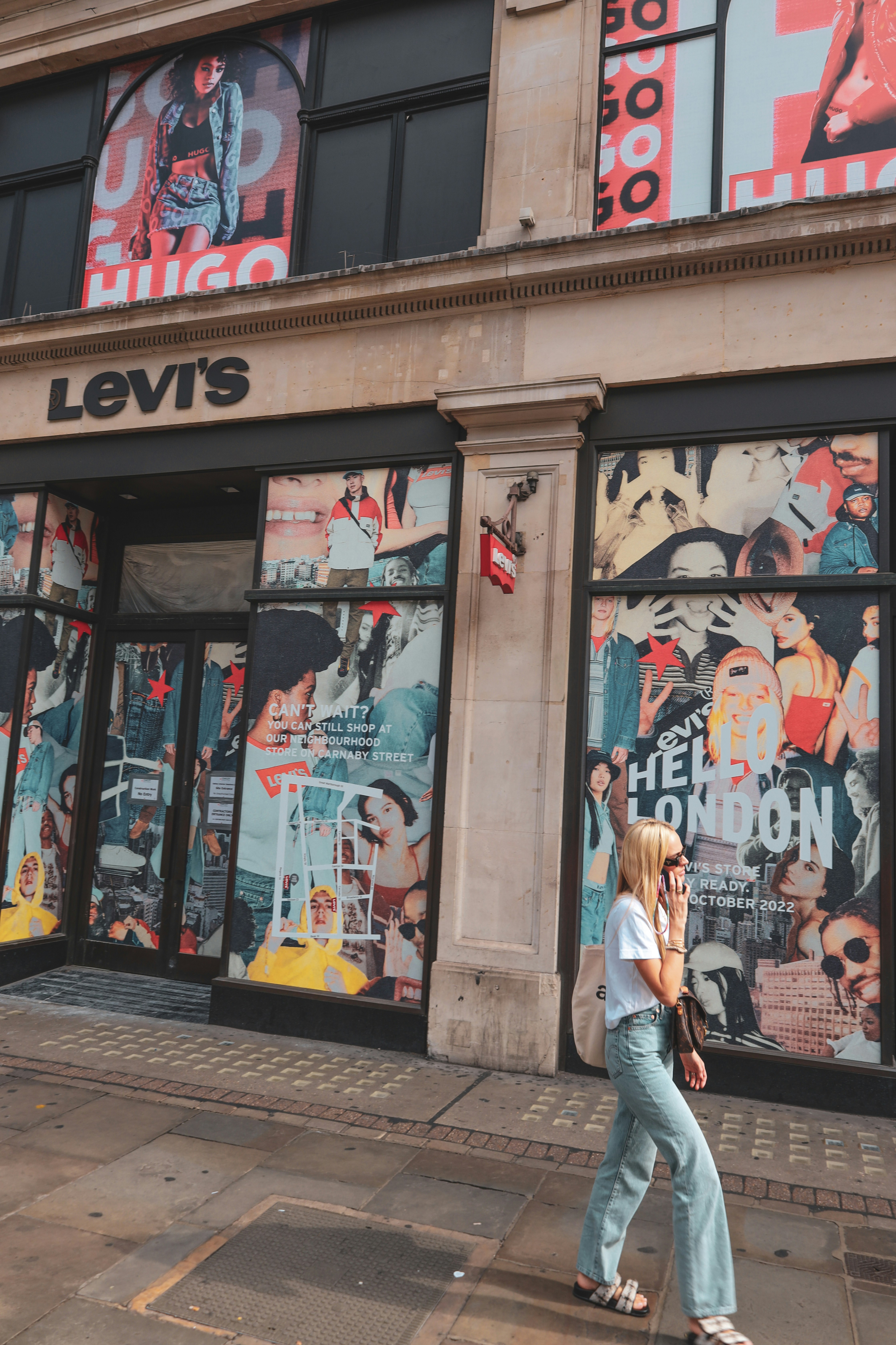 City Street Portrait: A Quiet Moment Amid Big Billboards