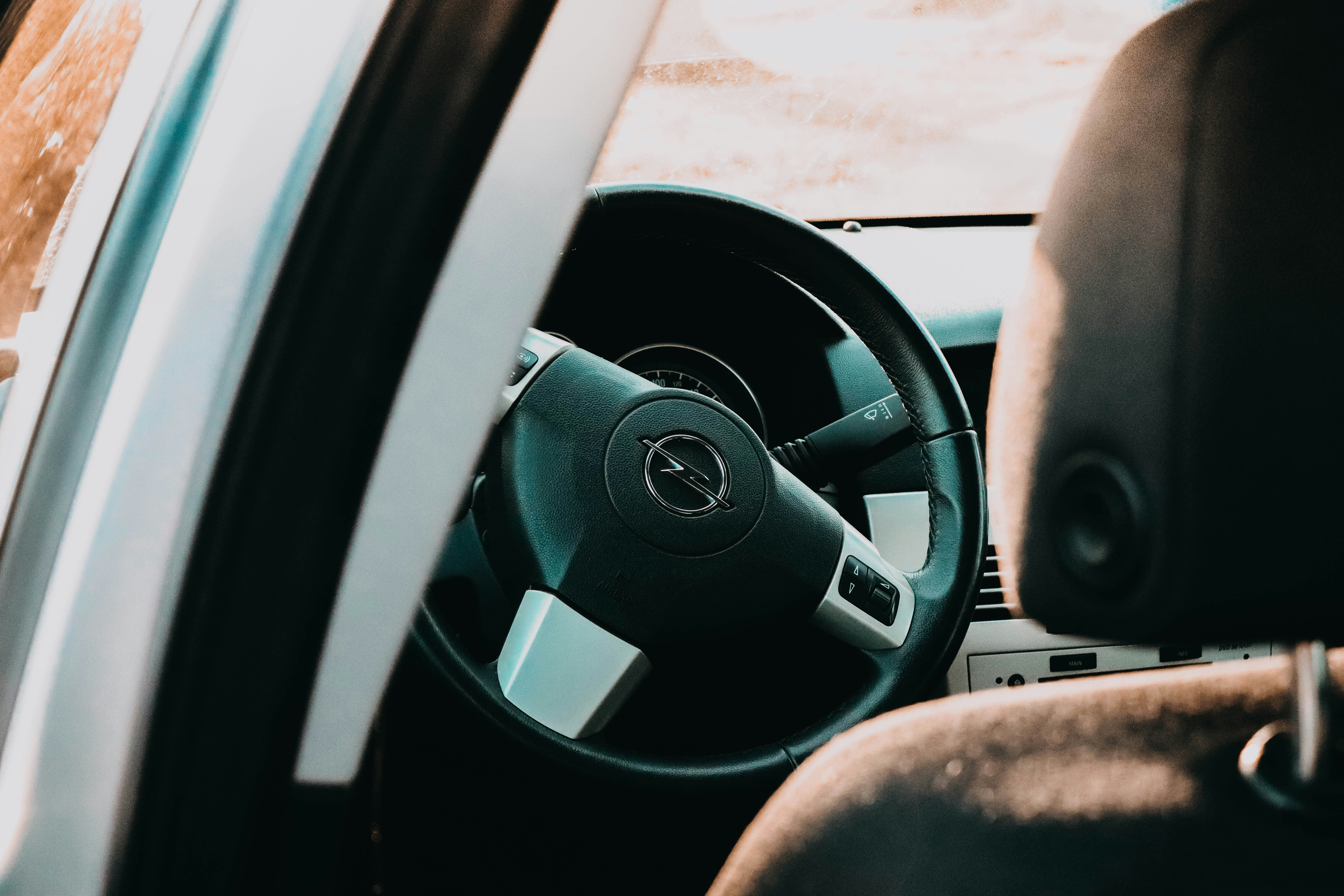 A steering wheel and dashboard of a car photo – Free Steering wheel ...