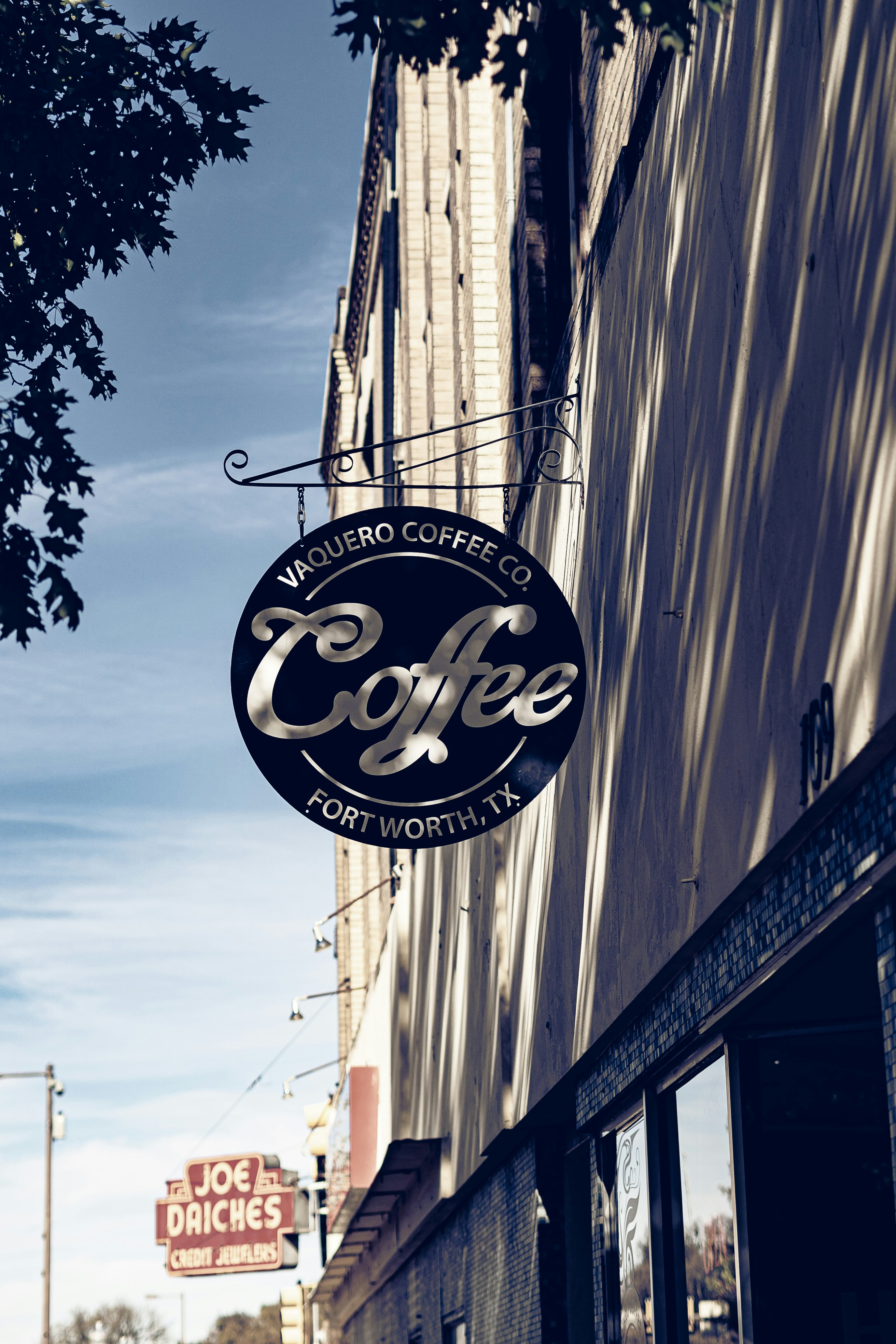 Circle of Coffee: A Vintage Sign Framed by Urban Facade