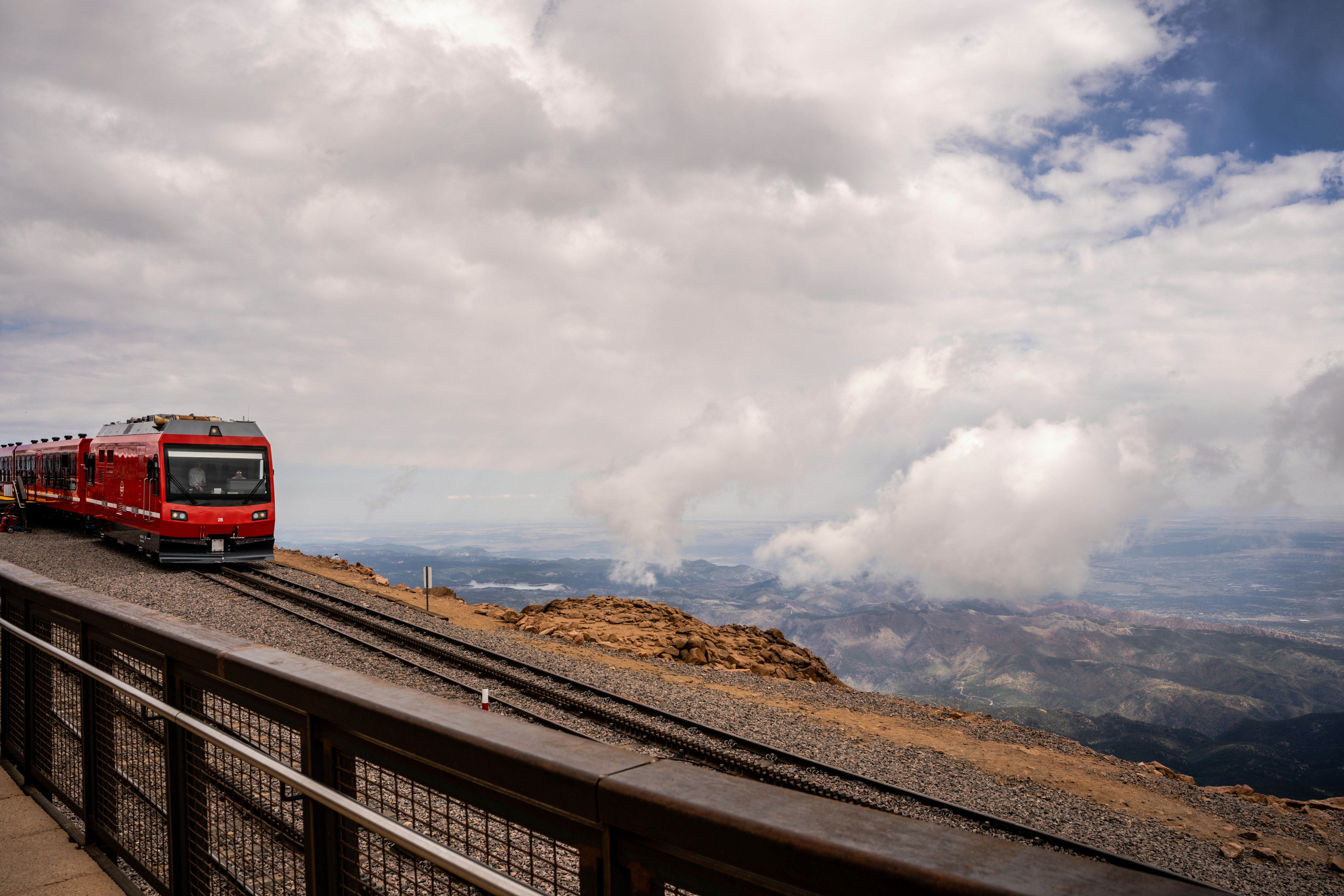 Red Locomotive at the Edge: Rails Along a Mountain Rim