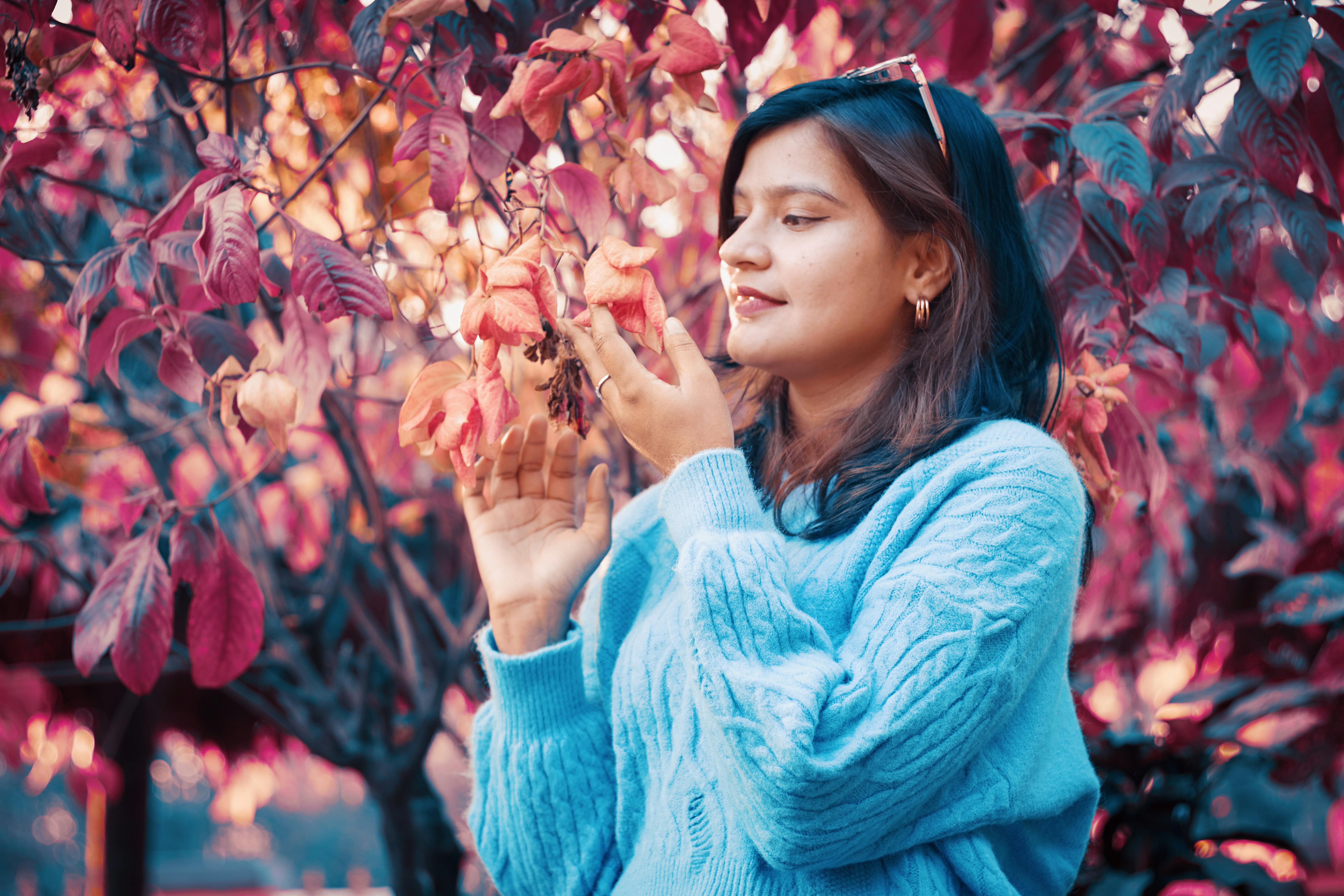 a woman holding a tree branch