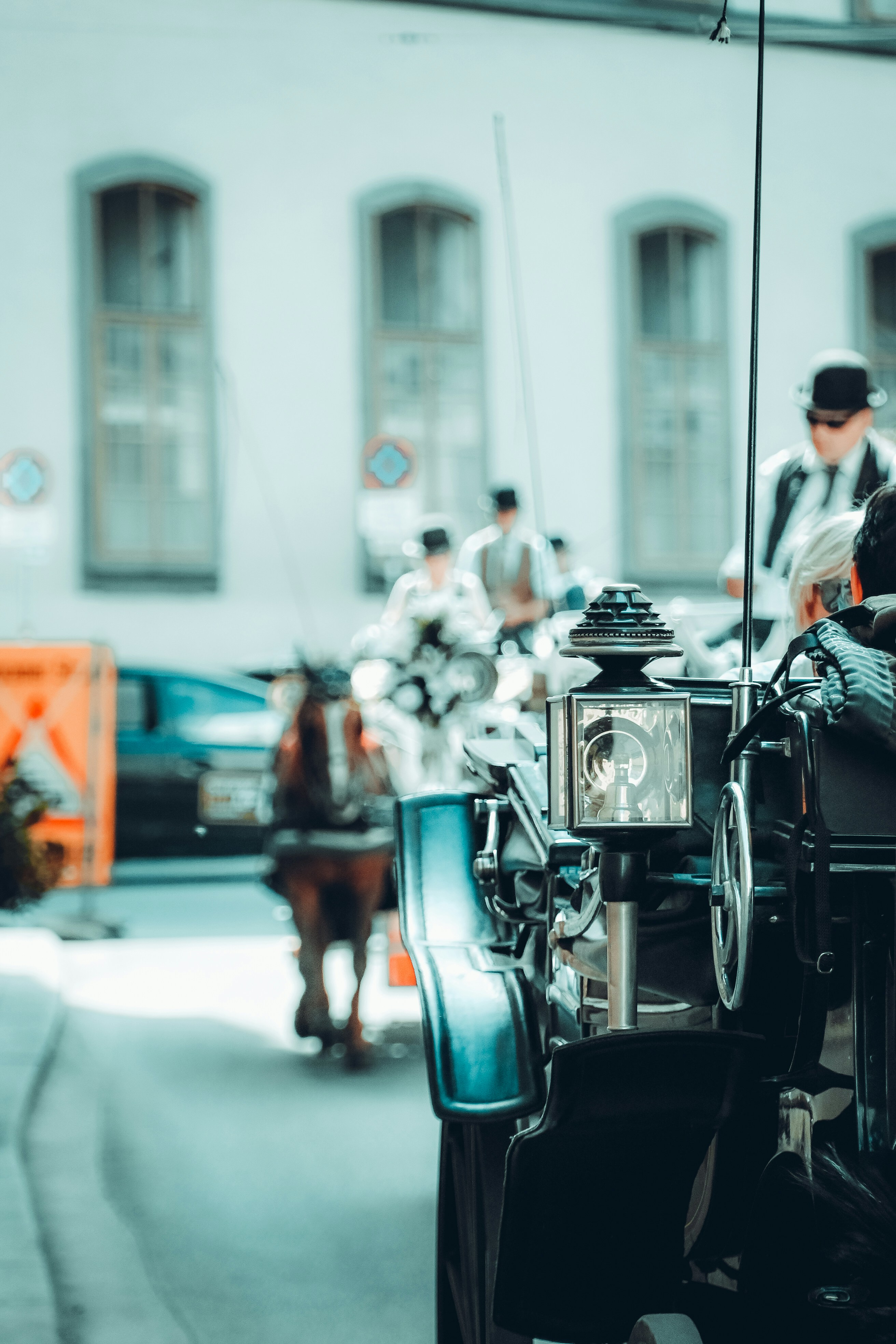 Lantern-Guarded Carriage Amid a Quiet City Blur