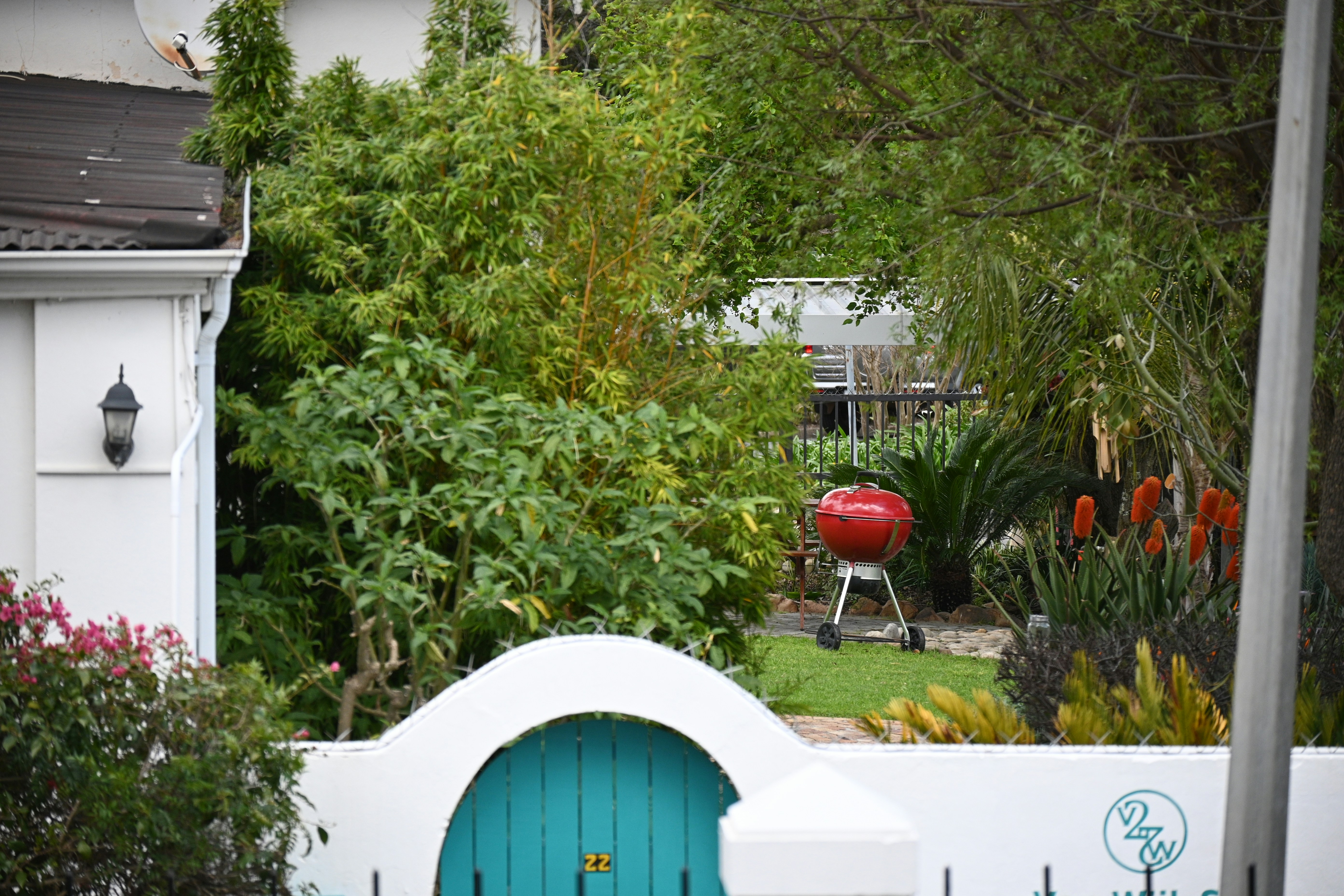 Red Weber barbecue in garden.
