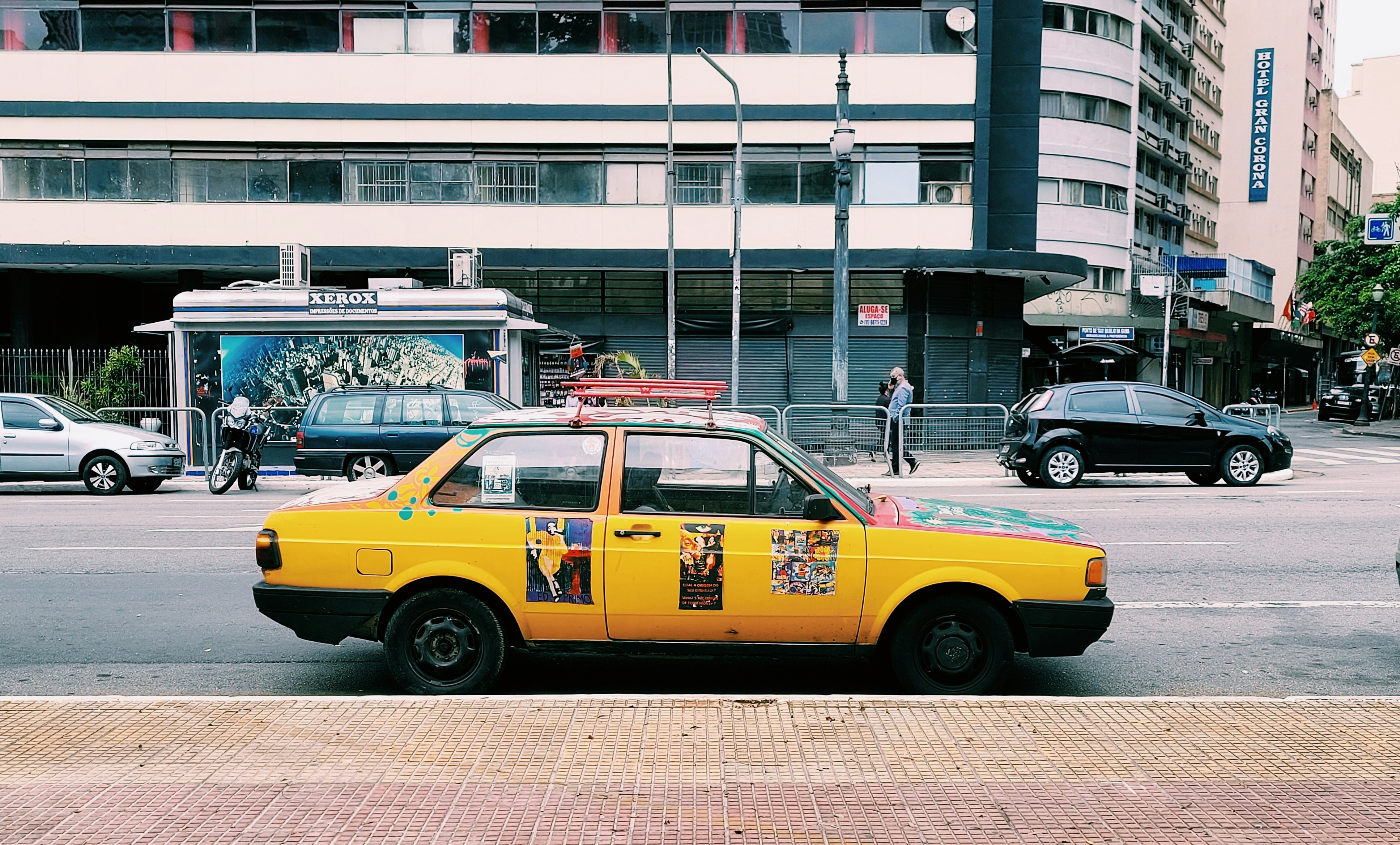 Doorway Gallery: Yellow Taxi with Posters in a City Street