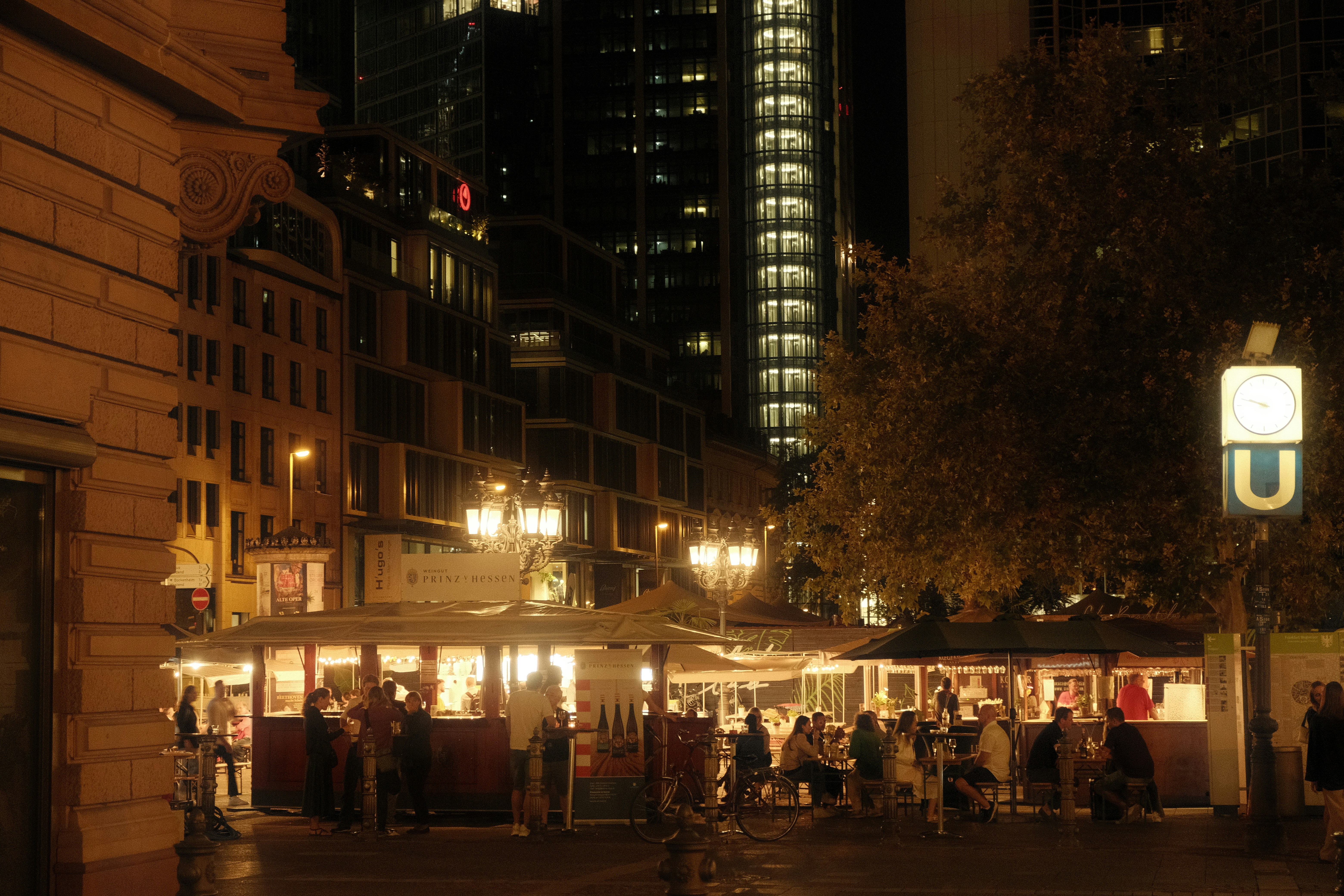 Amber Market Lights Under a Skyline of Glass
