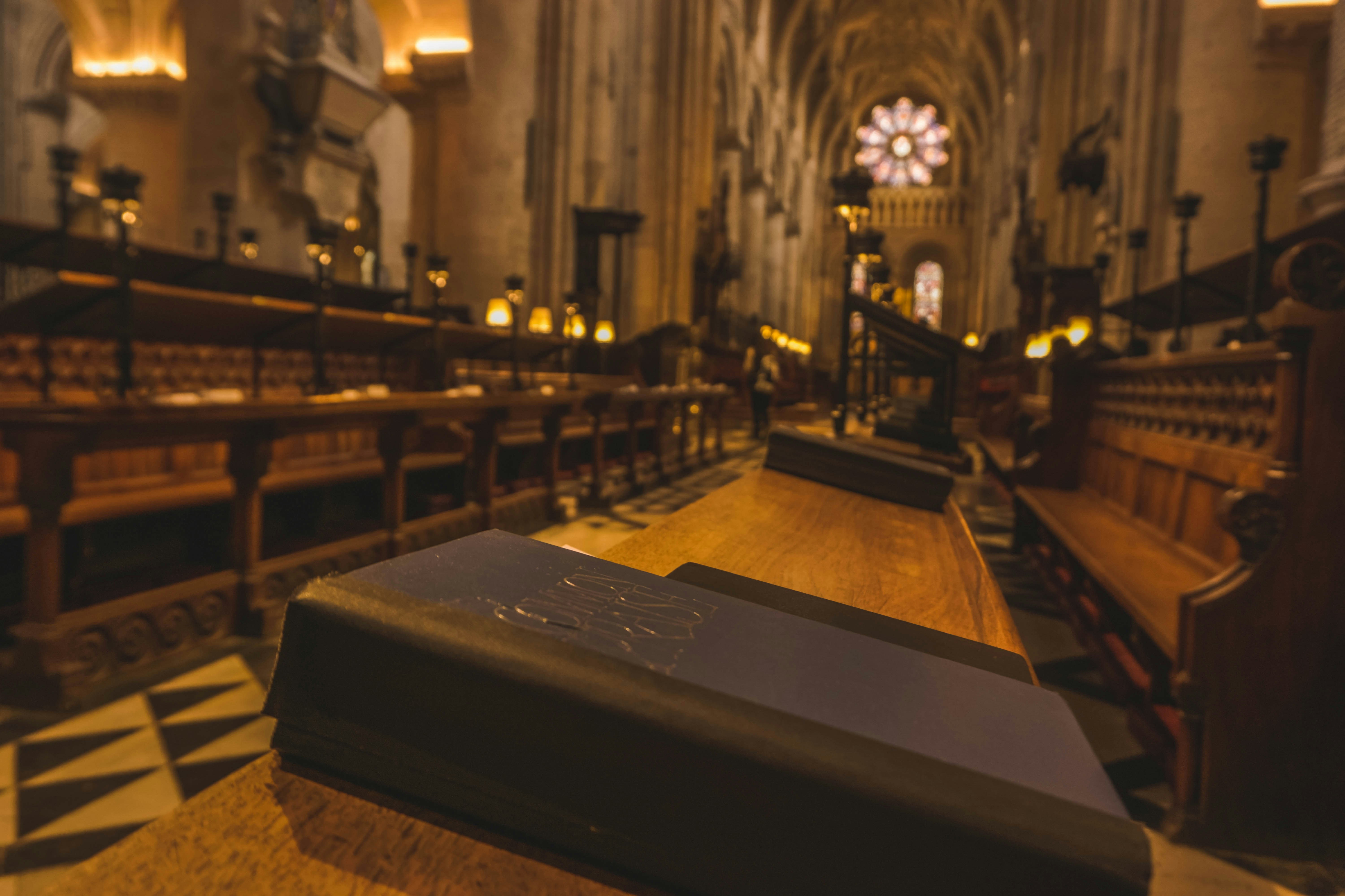Closed Book on a Sermon Lectern Beneath Lantern-Lit Gothic Arches