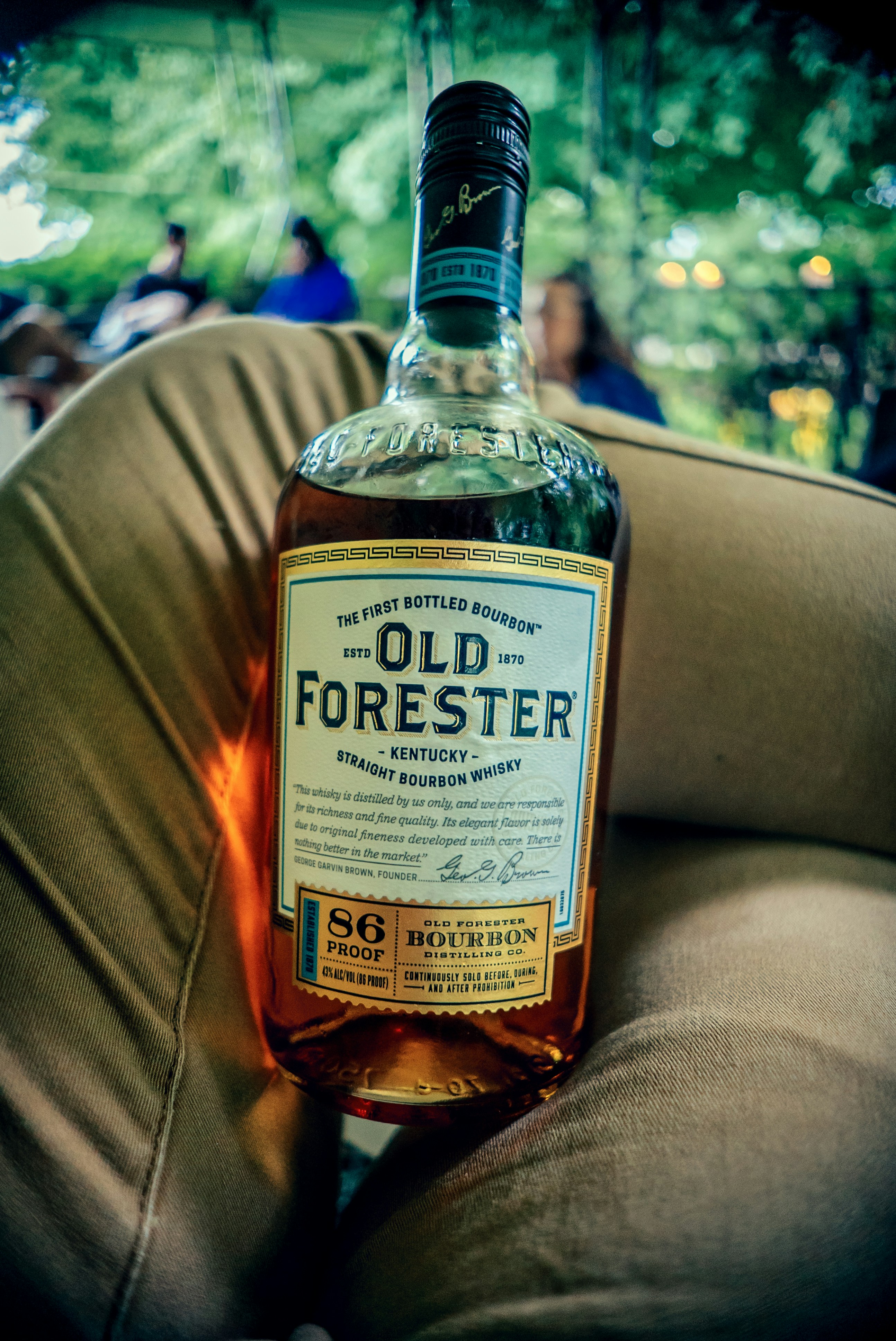 Close-Up Old Forester: Bourbon Bottle Anchored in Warm Lounge Light