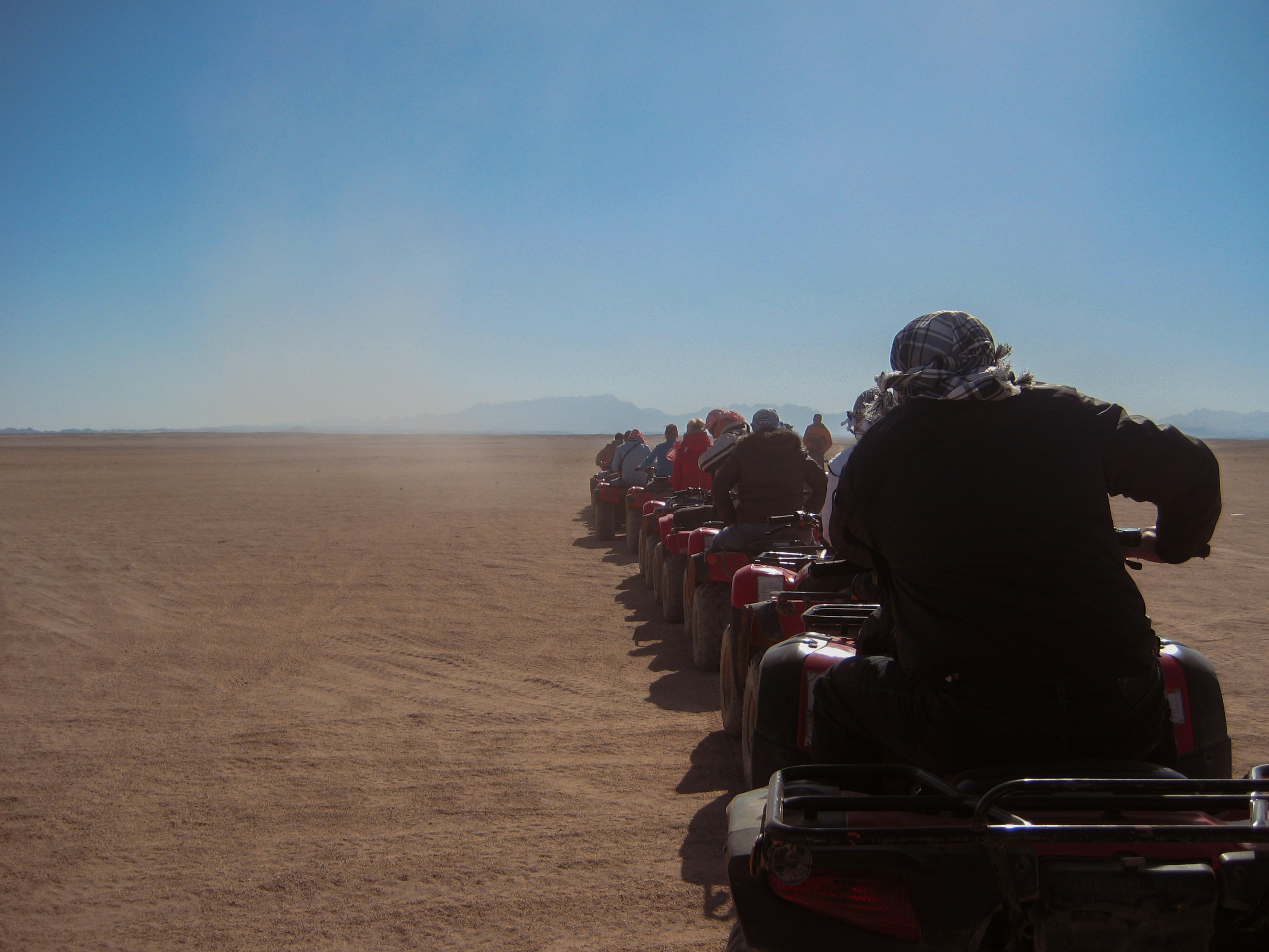 safari tourists on quad bikes in the desert