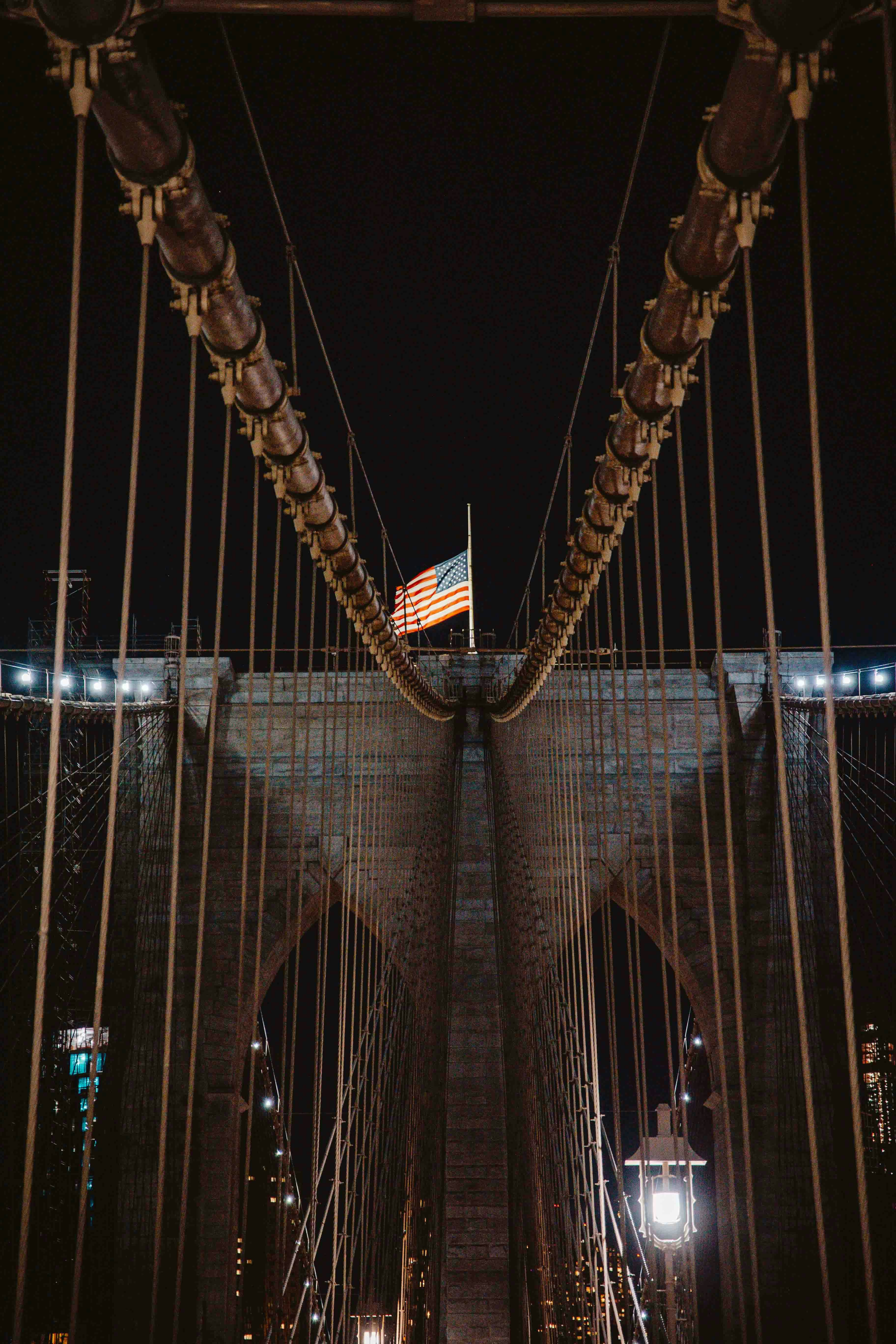 Flag at the Apex: Night Convergence of Brooklyn Bridge Cables
