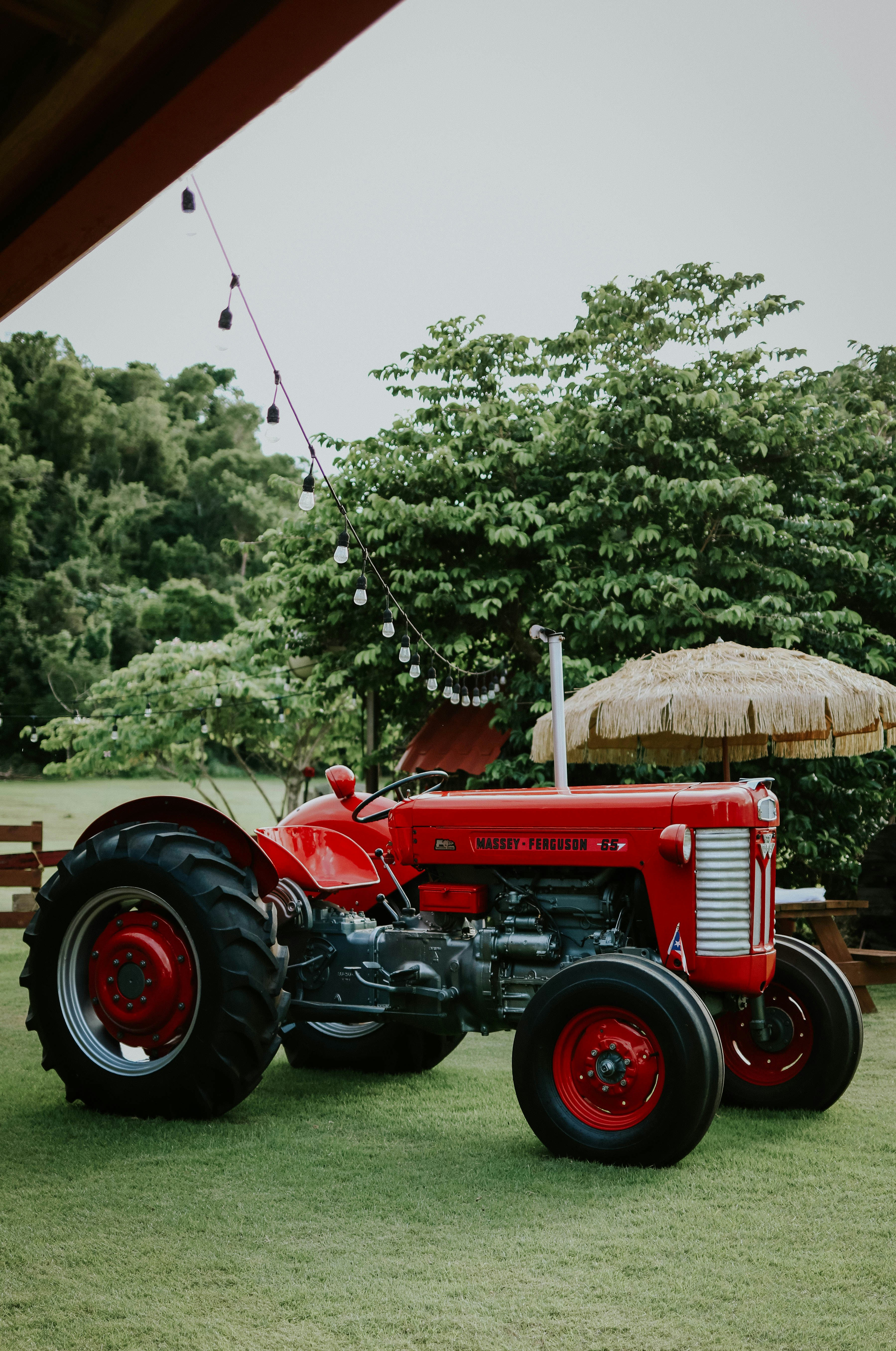 A red tractor on grass photo – Free Puerto rico Image on Unsplash