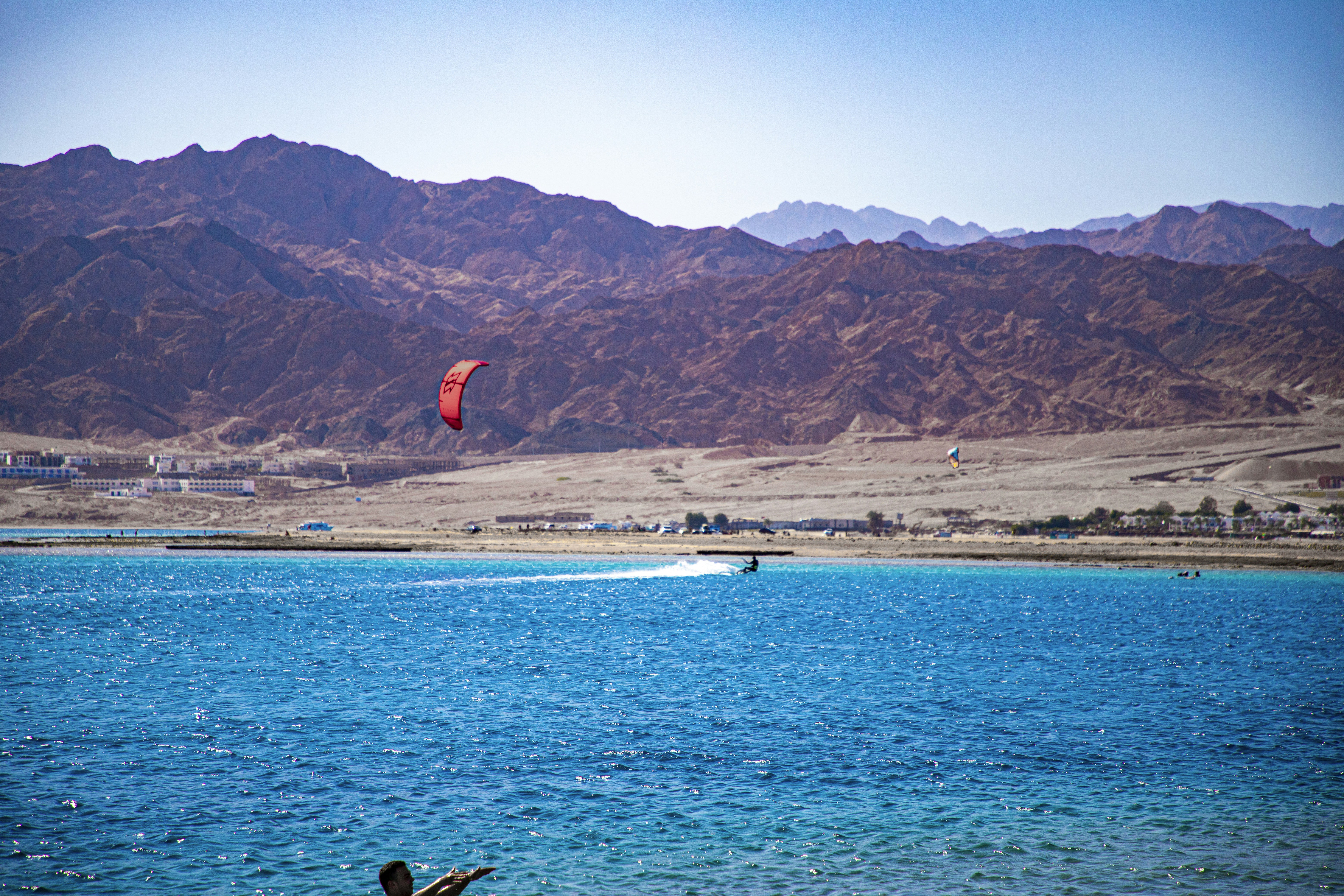 a person flying a kite over a body of water