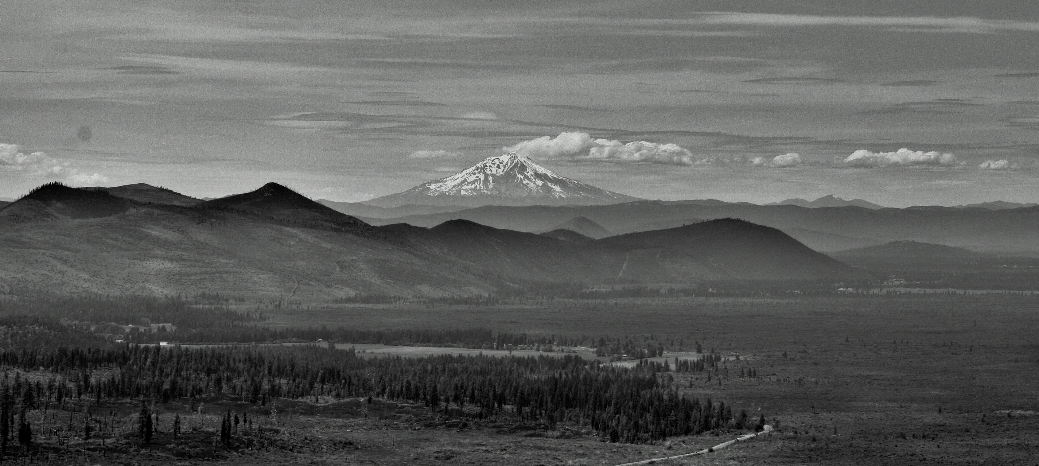Majestic Cascade: Snow Peak Rising Over a Silent Plateau