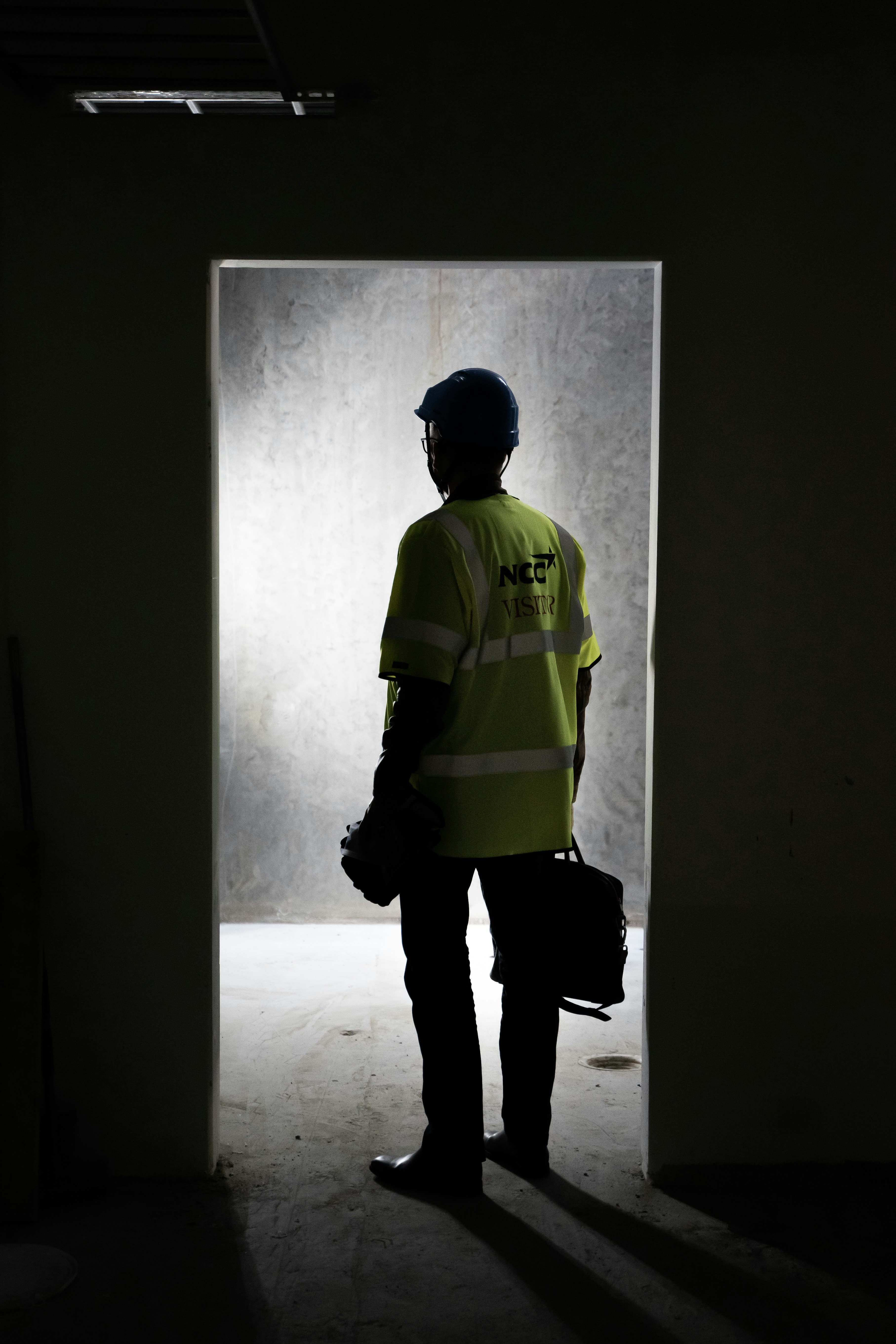 Backlit Sentinel: A High-Vis Figure at the Threshold