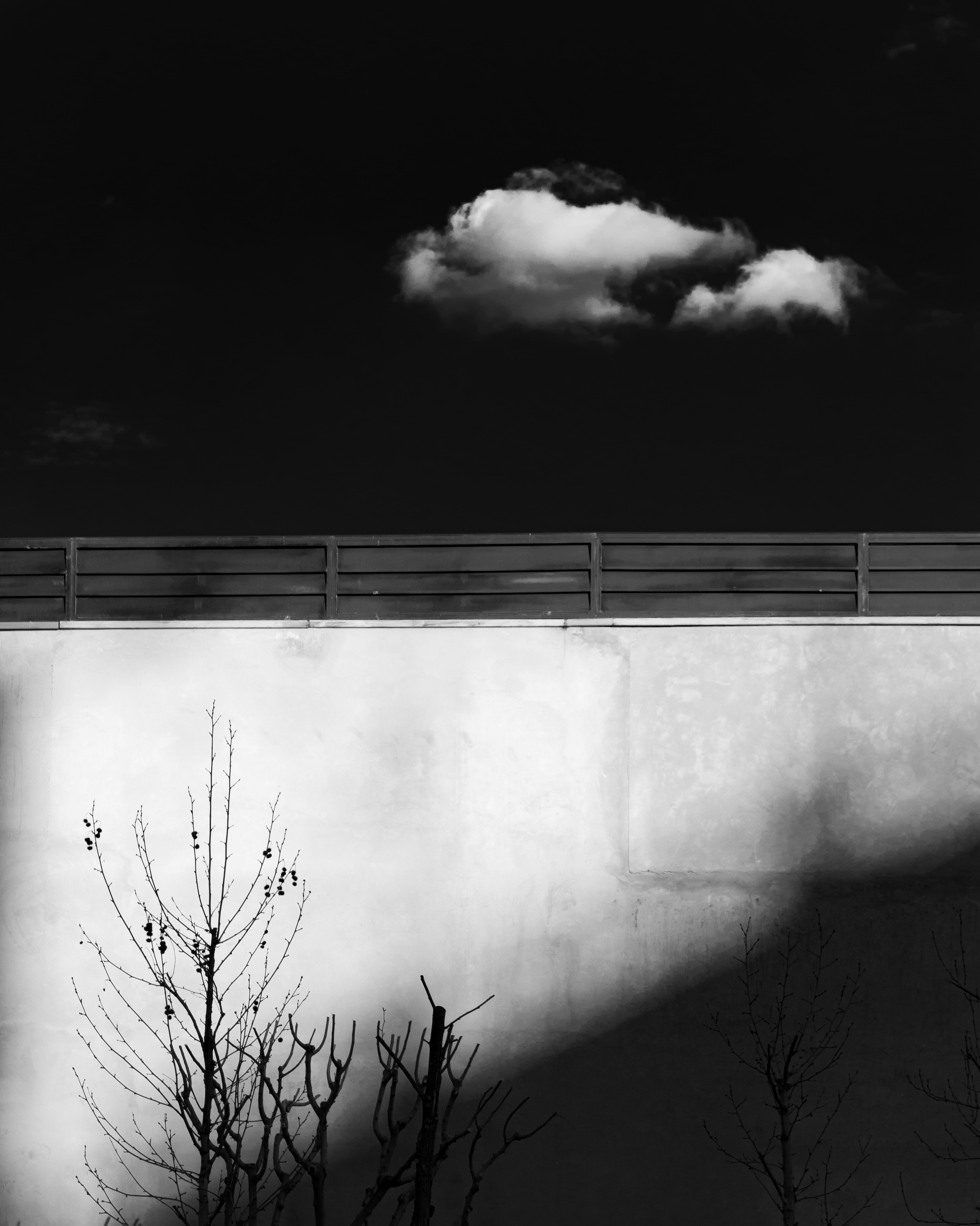 Cloud Above Concrete: A Monochrome Study in Shadow and Structure