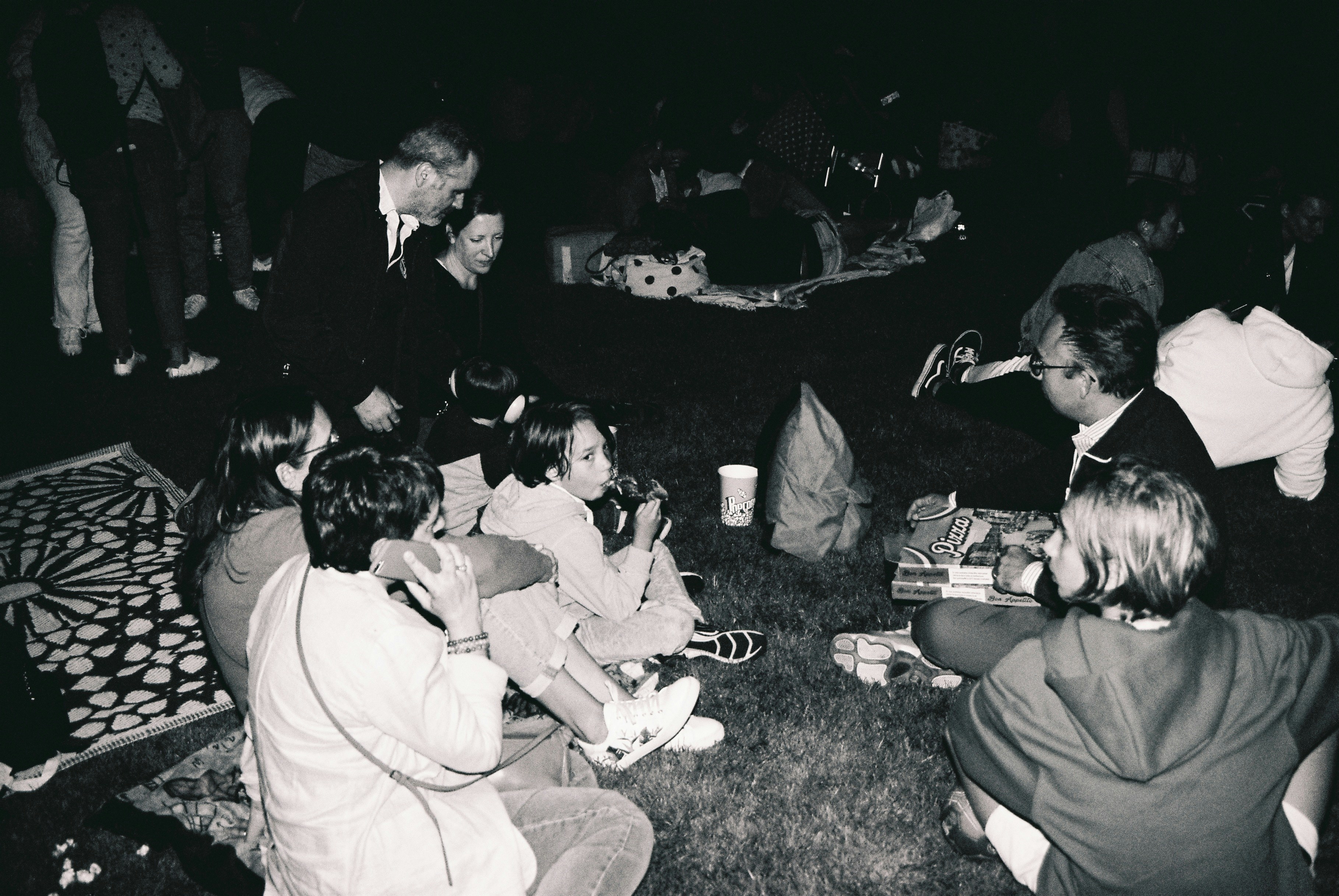 A group of people sitting on the ground eating food photo – Free Image ...