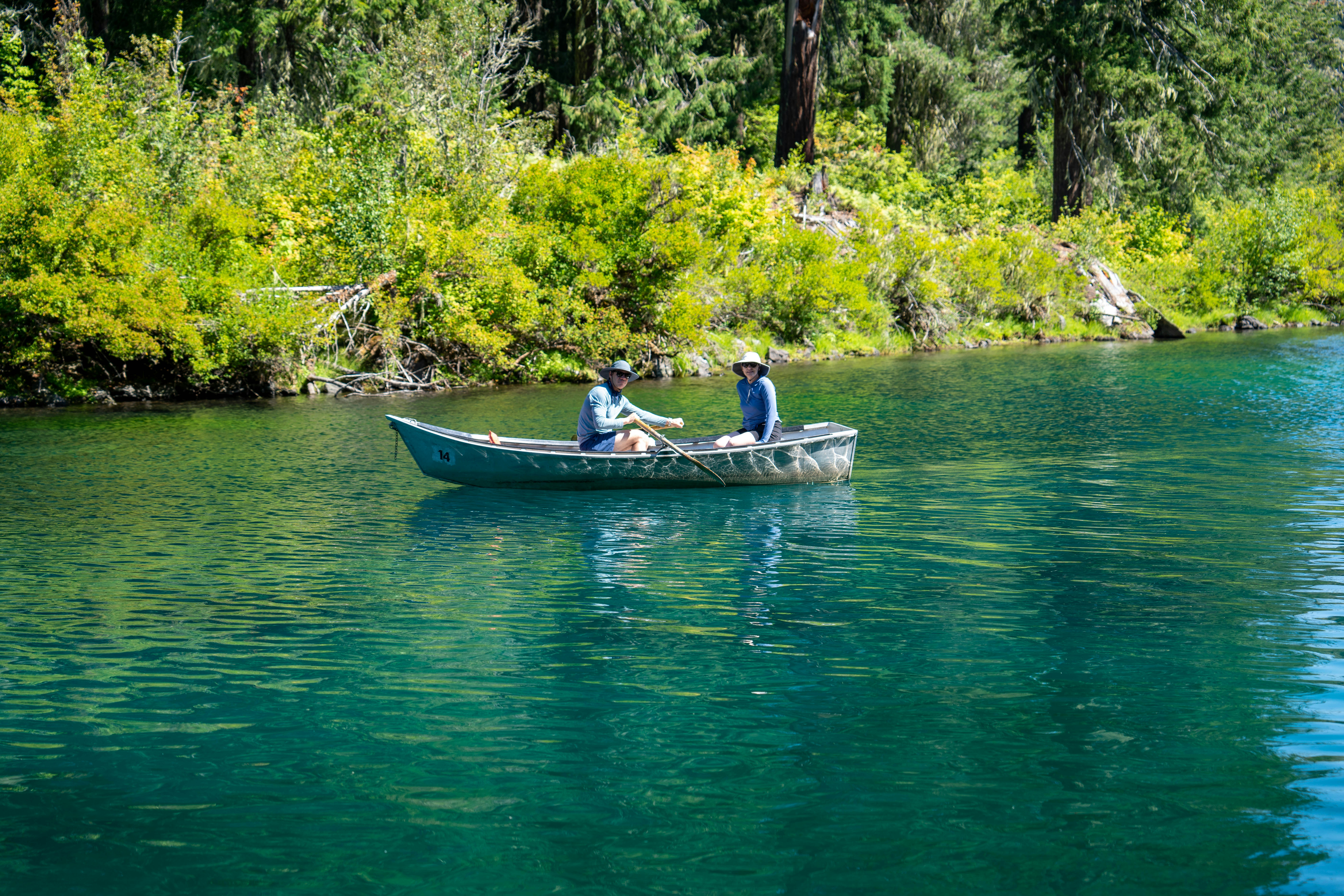 A couple of people in a canoe on a river photo – Free Human Image on ...