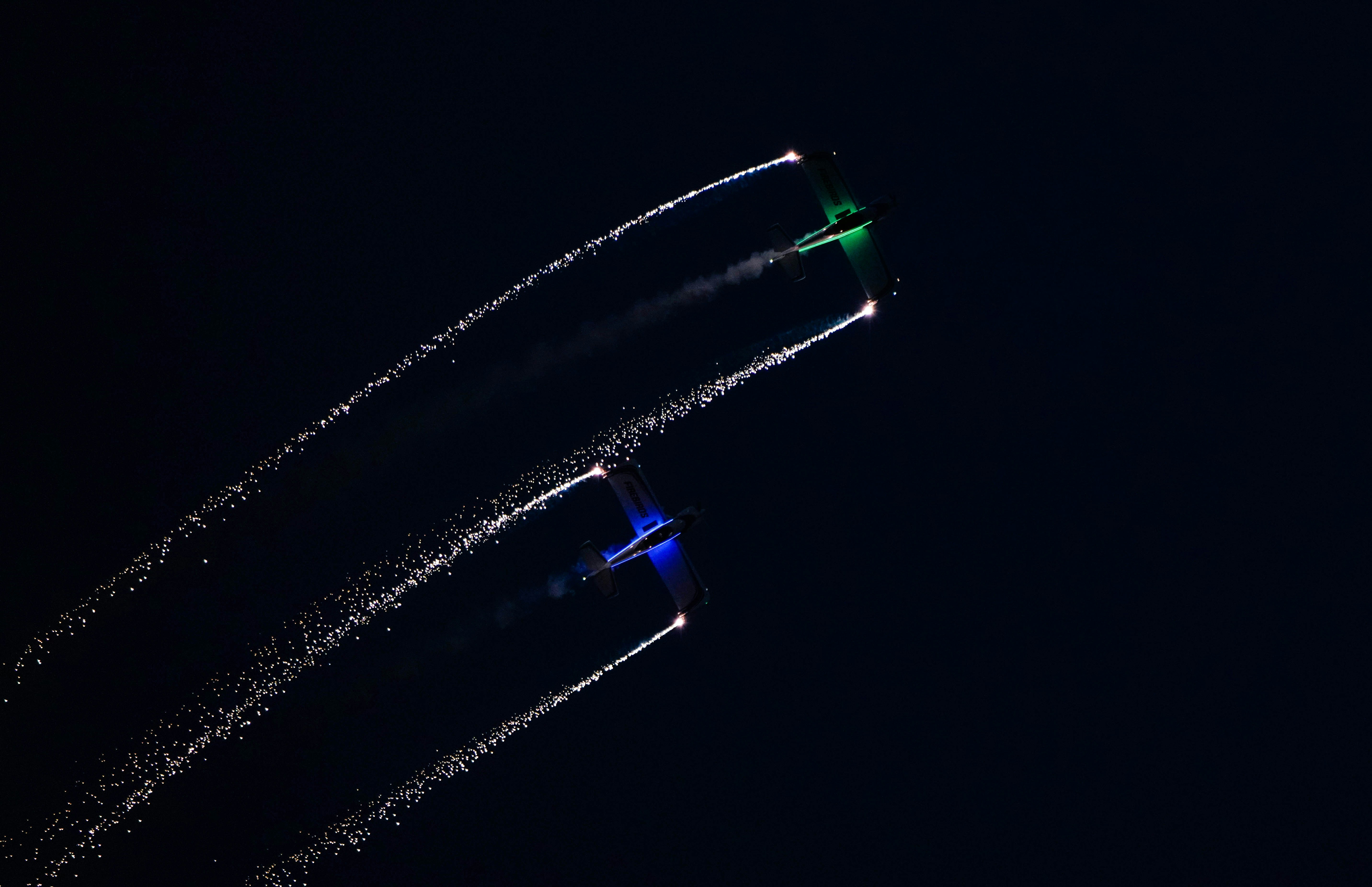 Trio of Neon Contrails Over a Velvet Night Sky