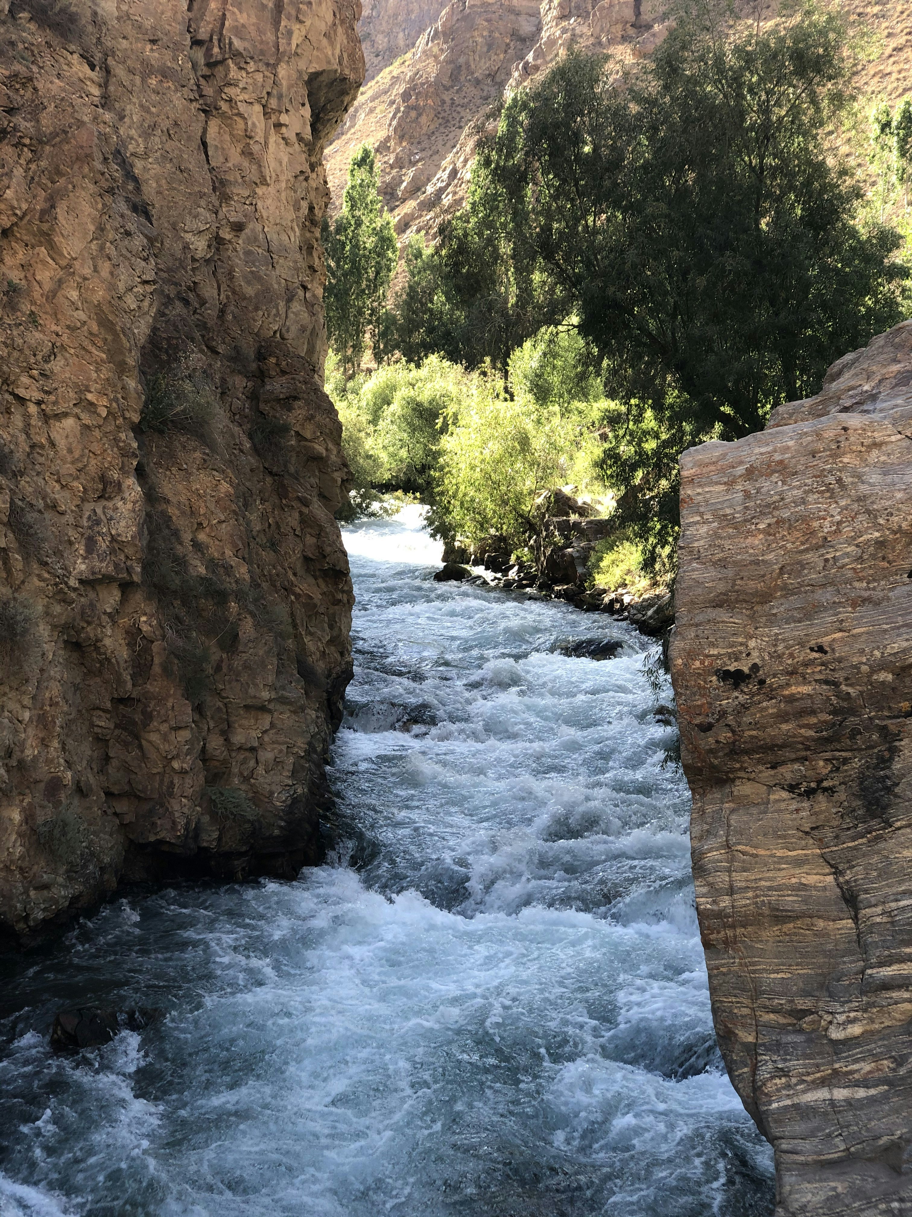 A river running between rocky cliffs photo – Free Badakhshan Image on ...