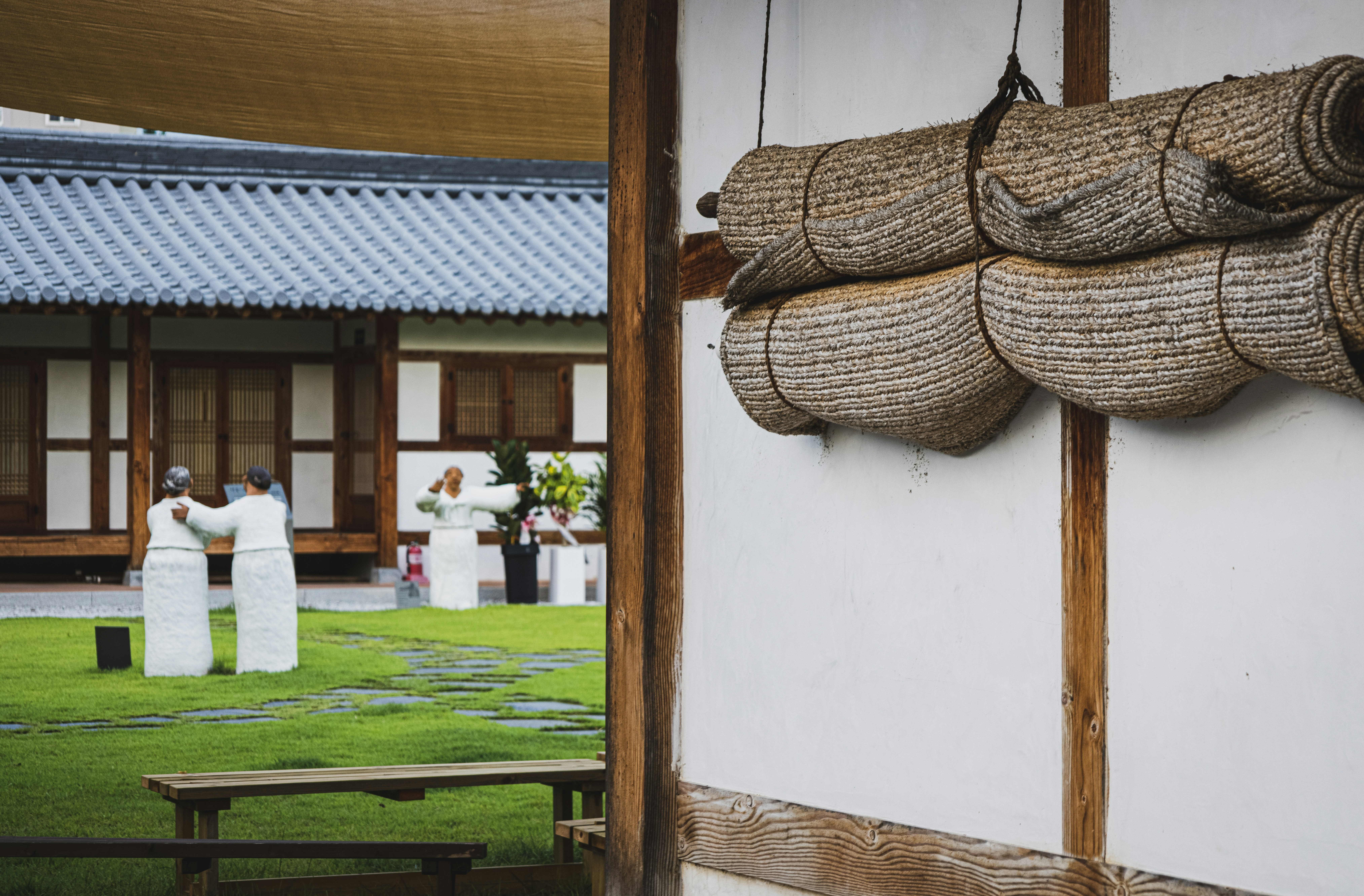 A couple of people in white robes standing in front of a building photo ...