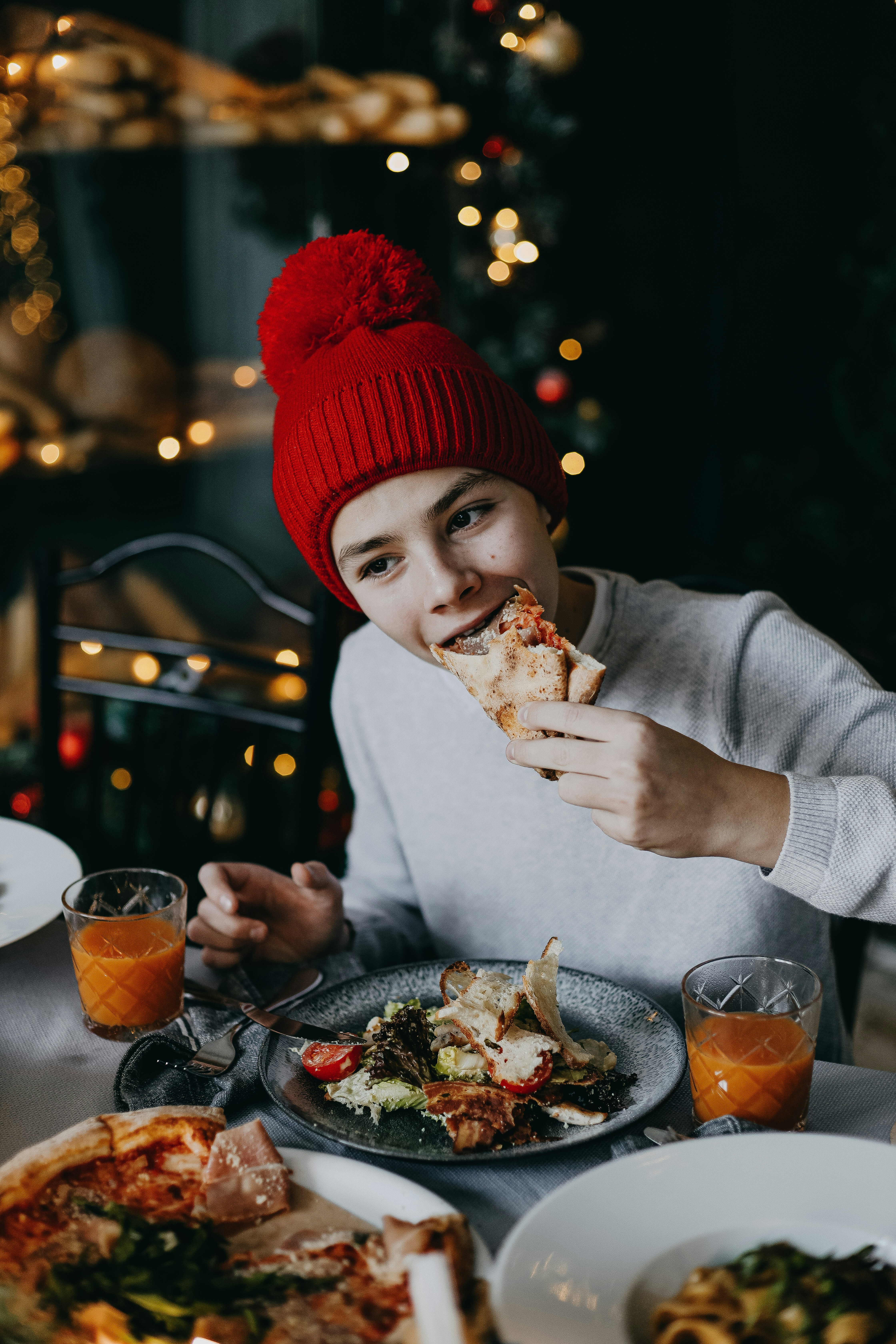 Crimson Beanie Moment: A Festive Bite Amid Soft Holiday Glow