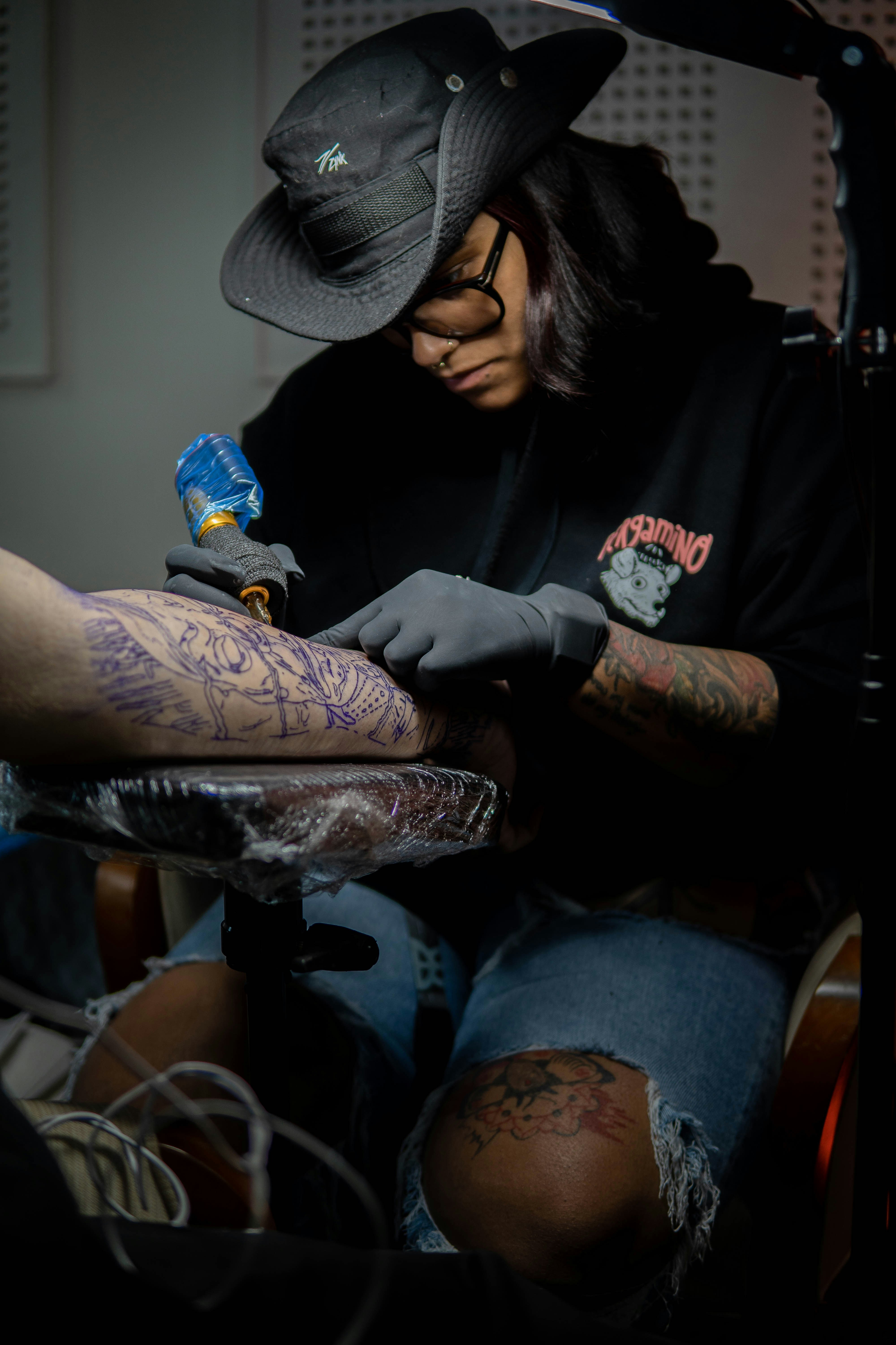 Under Studio Lights: Precision Tattooing on a Client's Leg