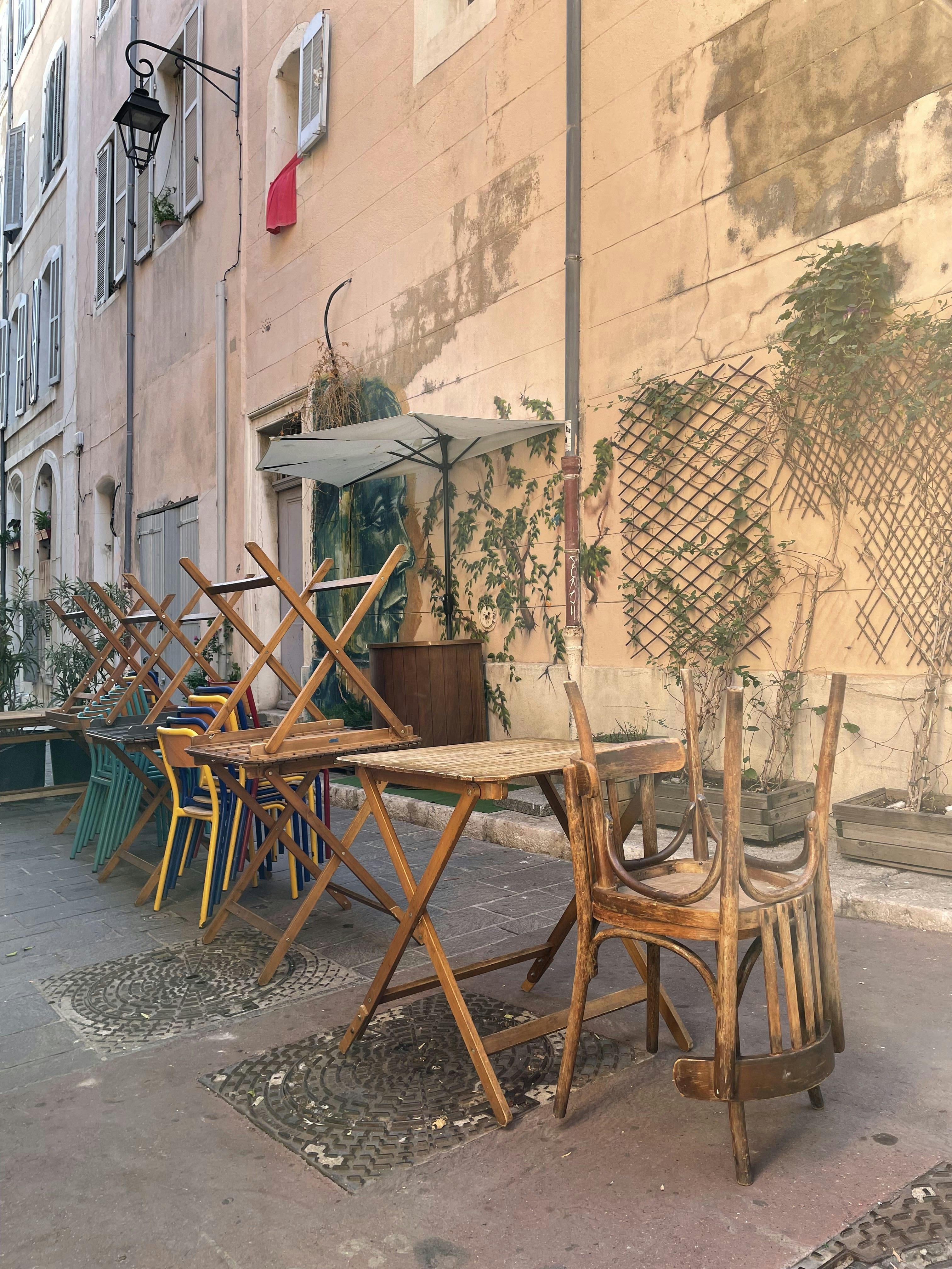 Piled chairs next to a closed restaurant in Marseille