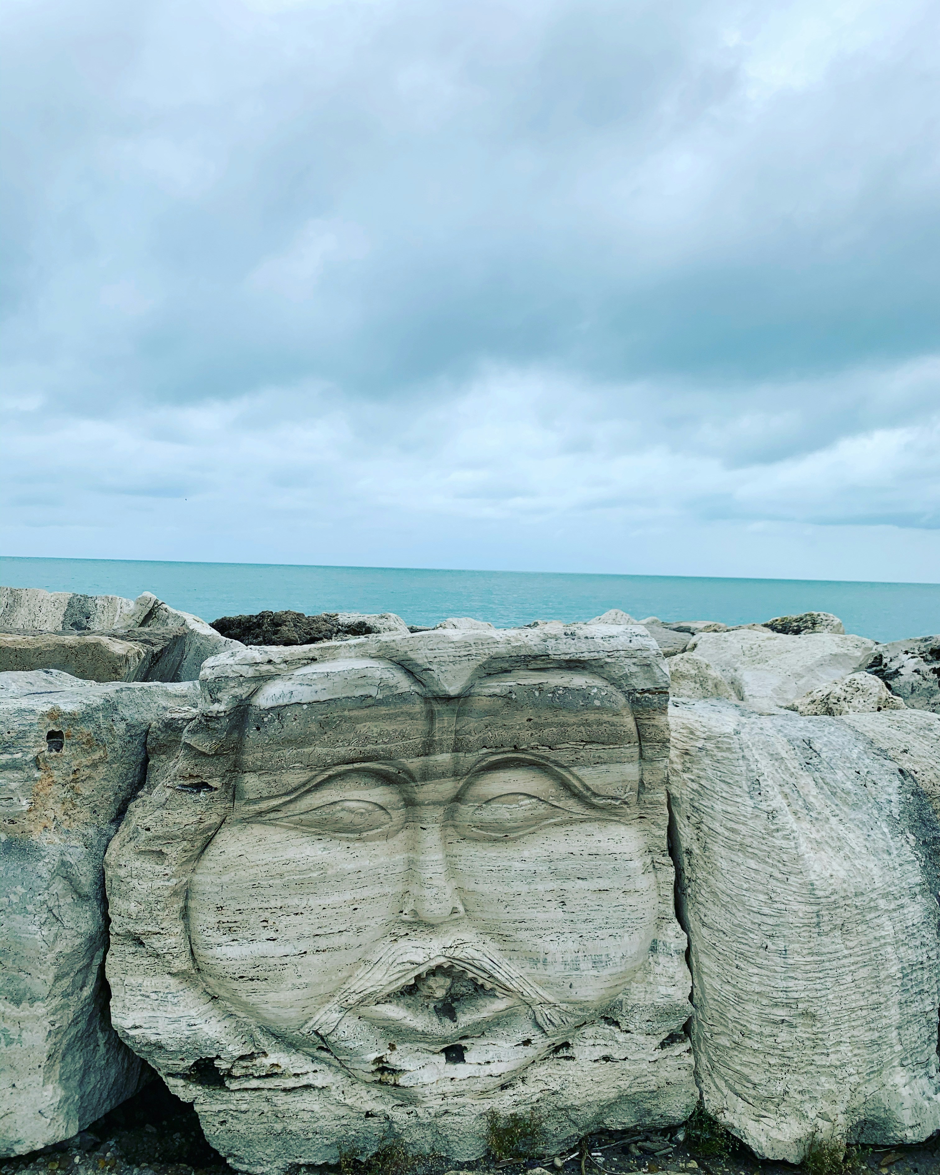 Stone Face by the Breakwater: A Seaside Carving