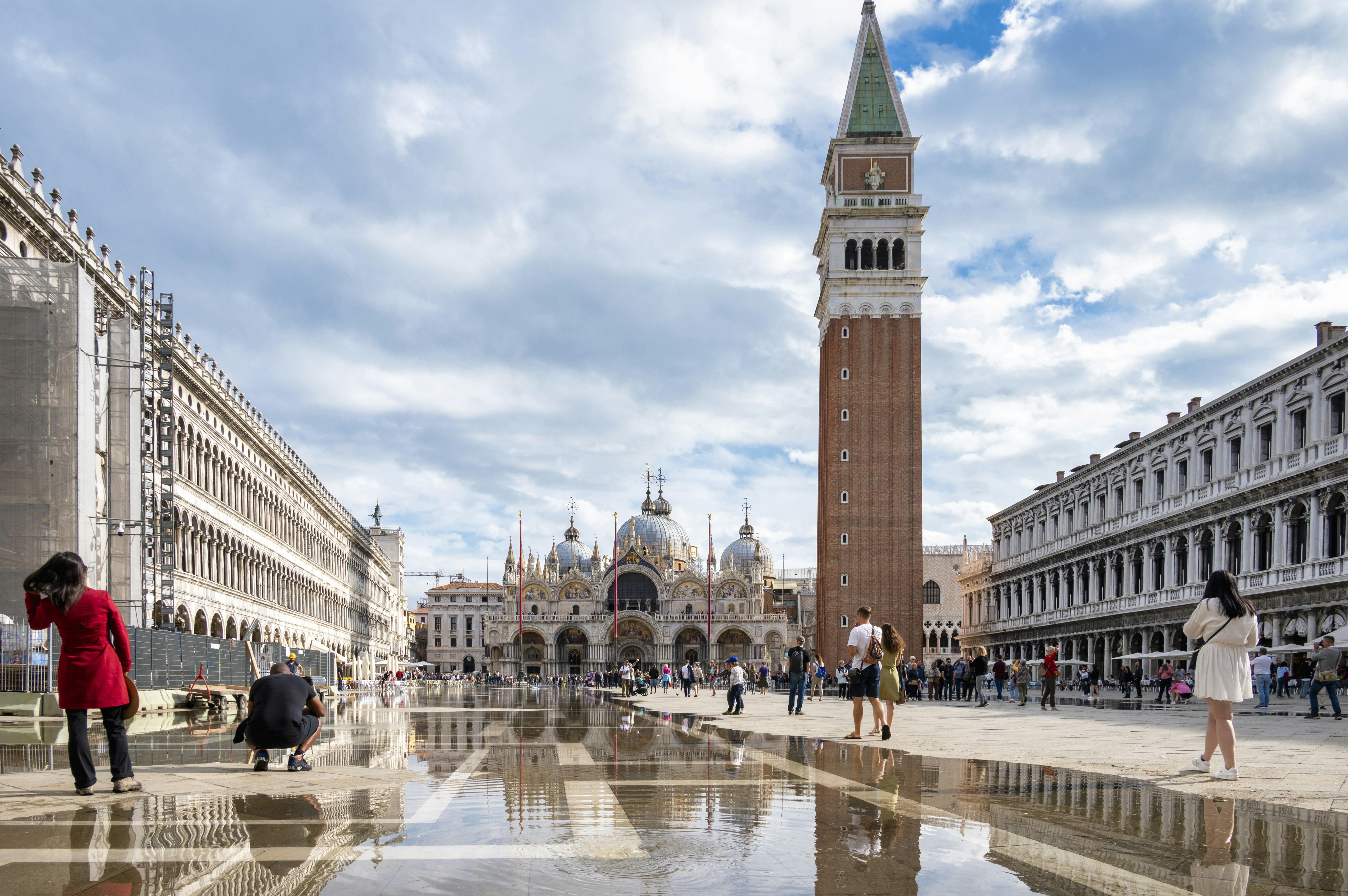 Piazza San Marco with the Basilica of Saint Mark and the bell tower of St Mark's Campanile | a large courtyard with Piazza San Marco in the middle of it