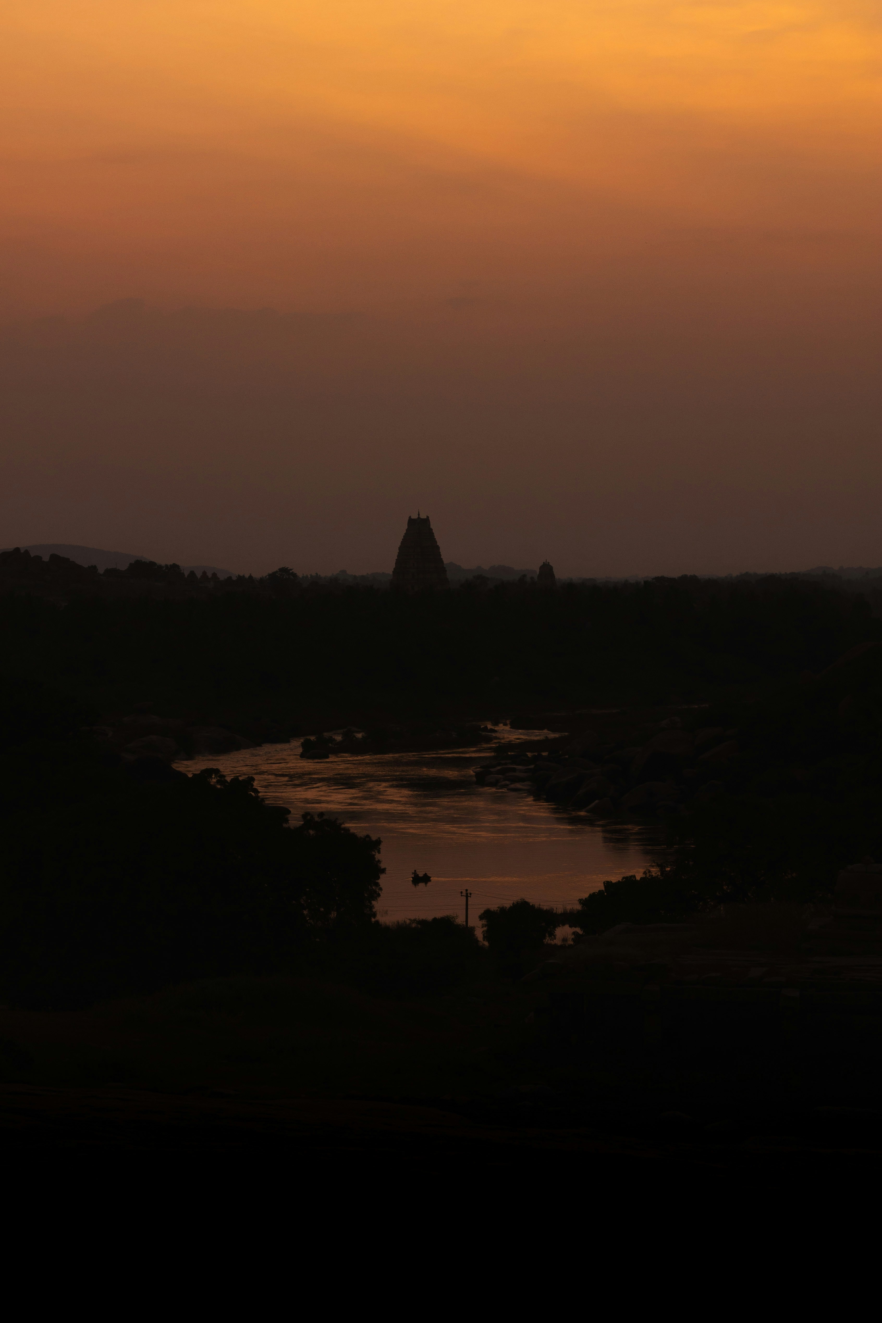 Distant Ruin at Dusk: A Silhouette Over a Quiet River