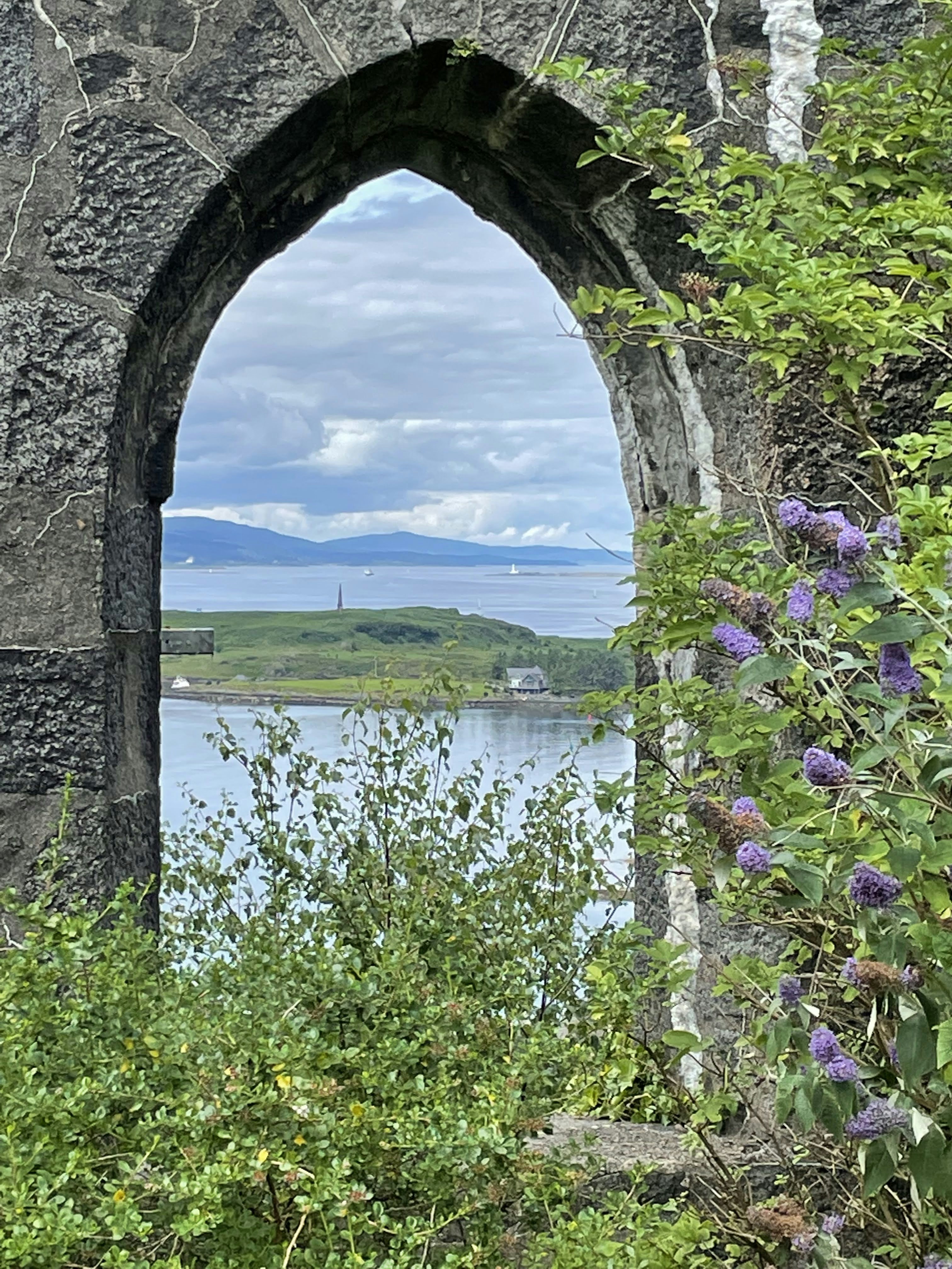 A view of a lake through a stone archway photo – Free Mccaig's tower ...