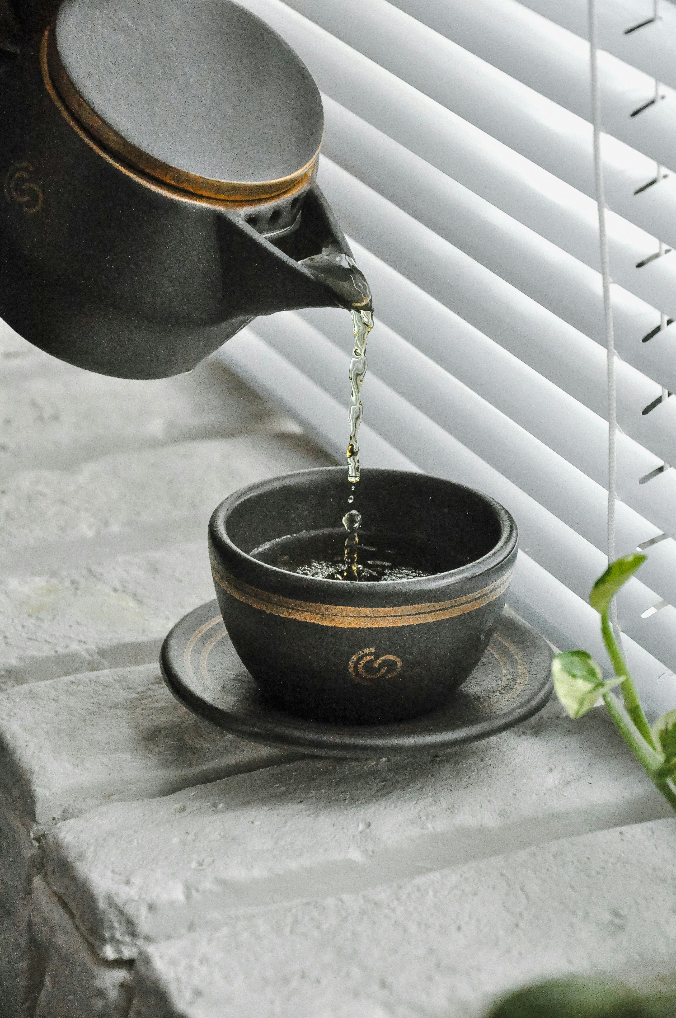 Evening Pour by Slatted Light: A Quiet Moment with Dark Ceramic