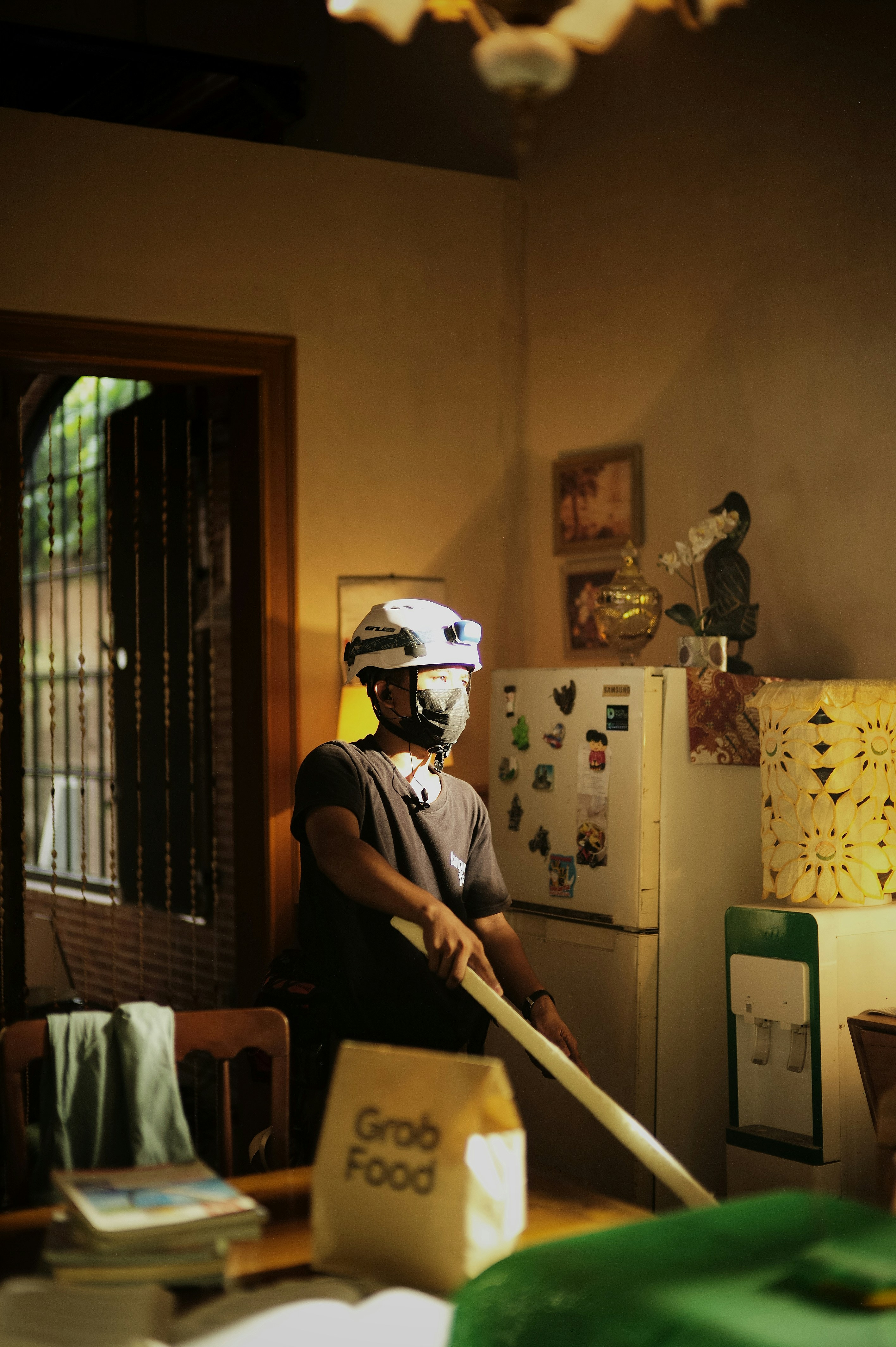 A person wearing a helmet and holding a broom photo – Free Brown Image ...