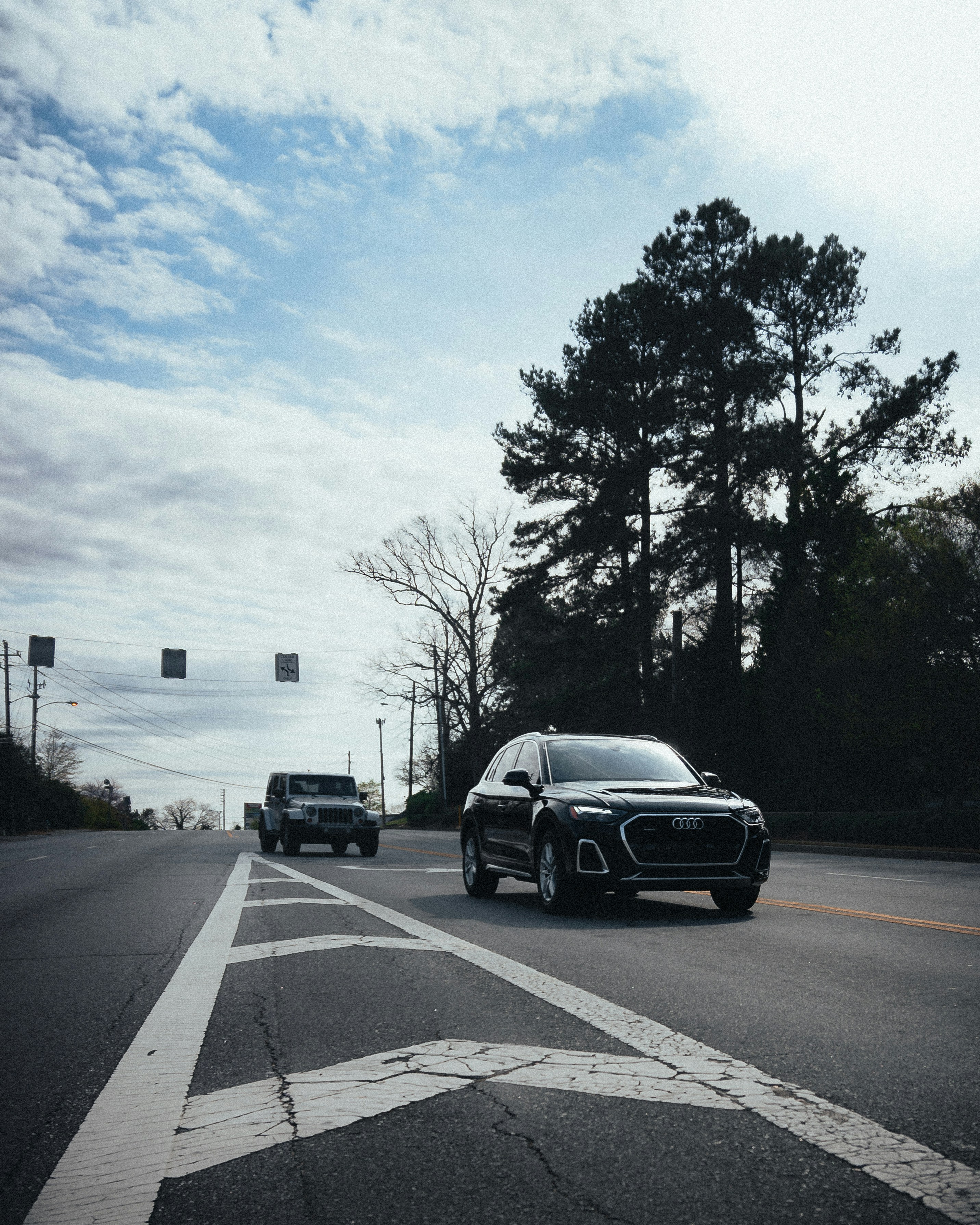 Leading the Quiet Arc: A Black Audi on the Suburban Road