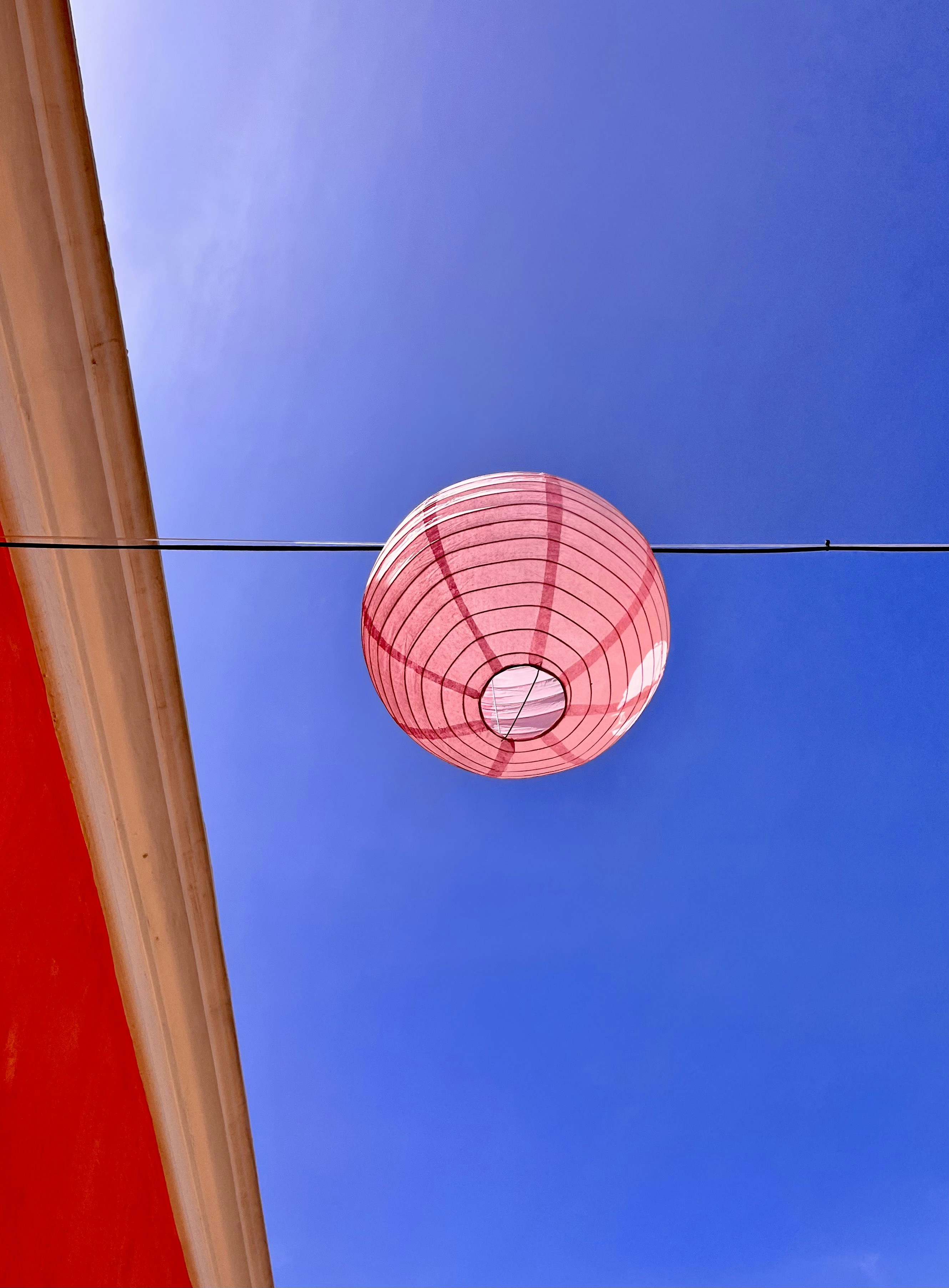 Crimson Lantern Against a Cerulean Sky