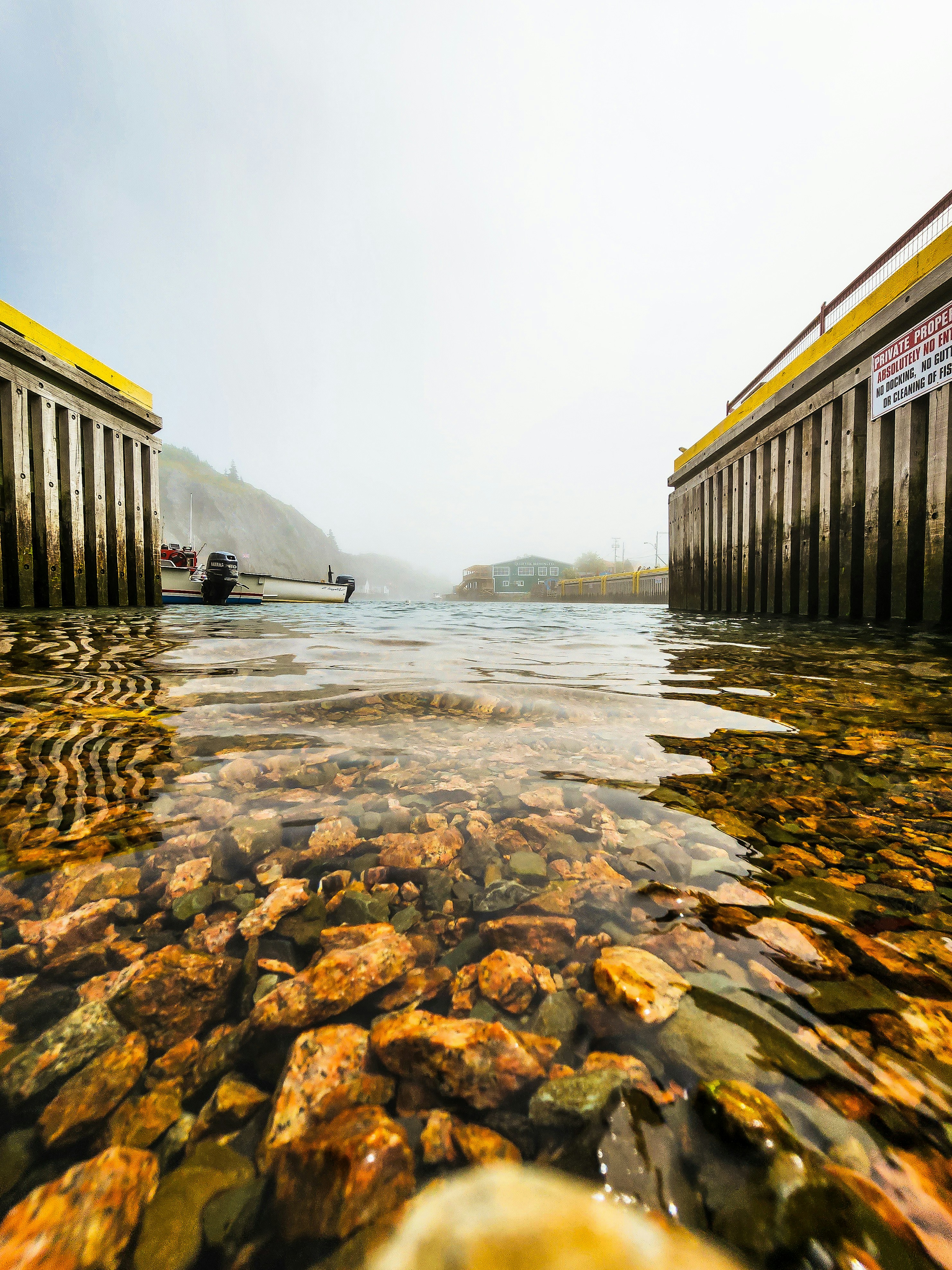 A body of water with rocks and a boat in it photo – Free Nl Image on ...