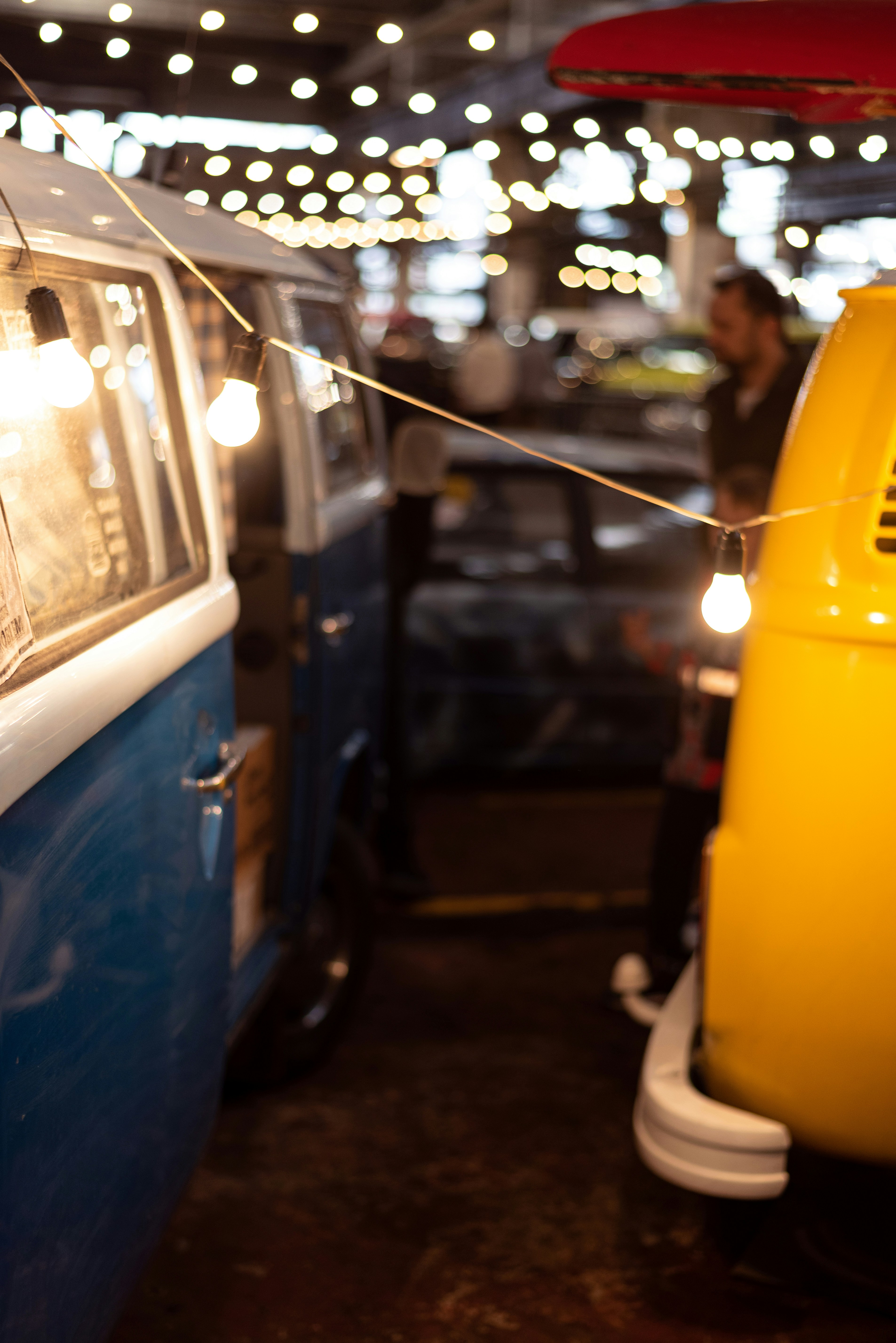 Warm Bulbs Between Vintage Vans in a Night Market