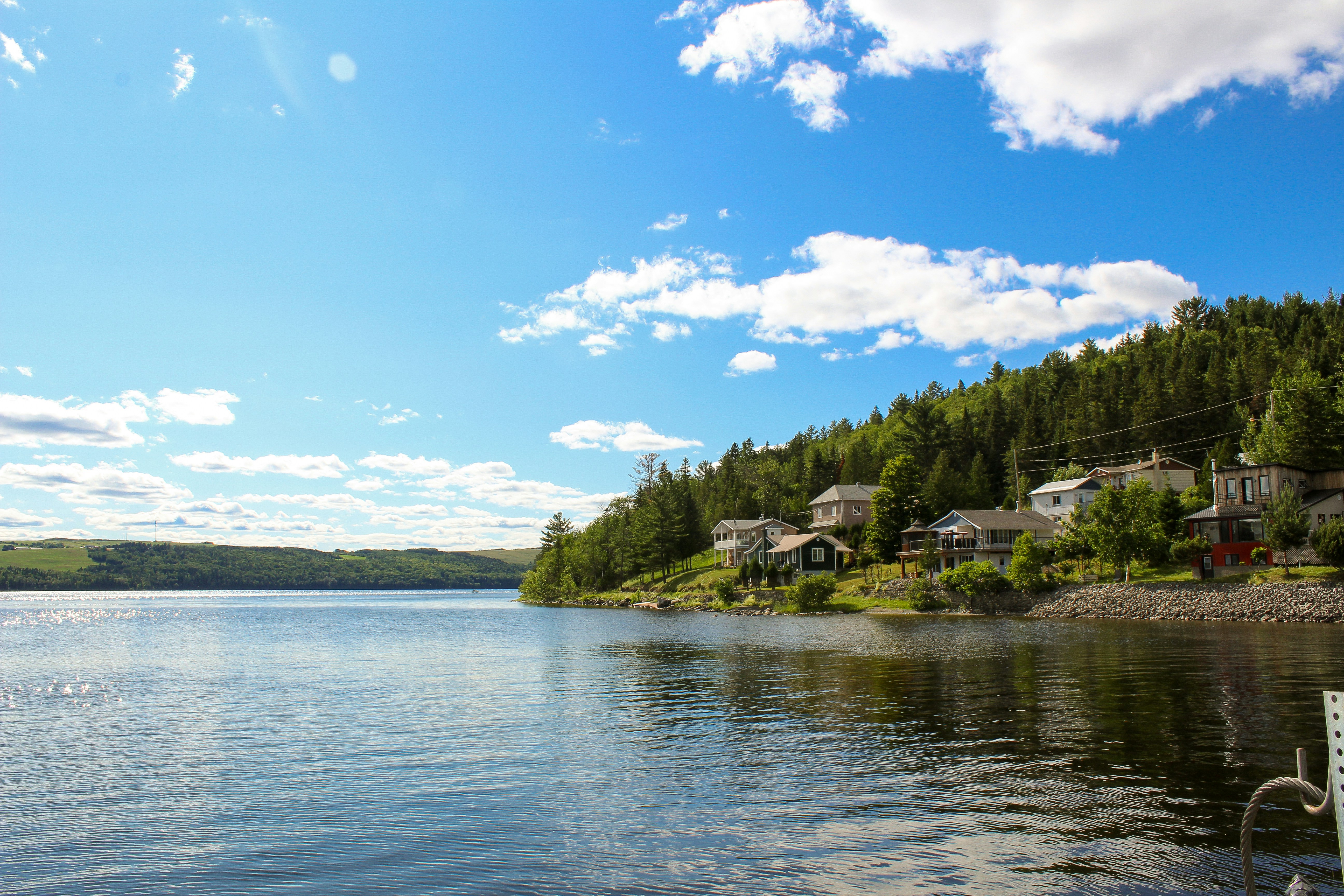 A body of water with houses and trees around it photo – Free Saint ...