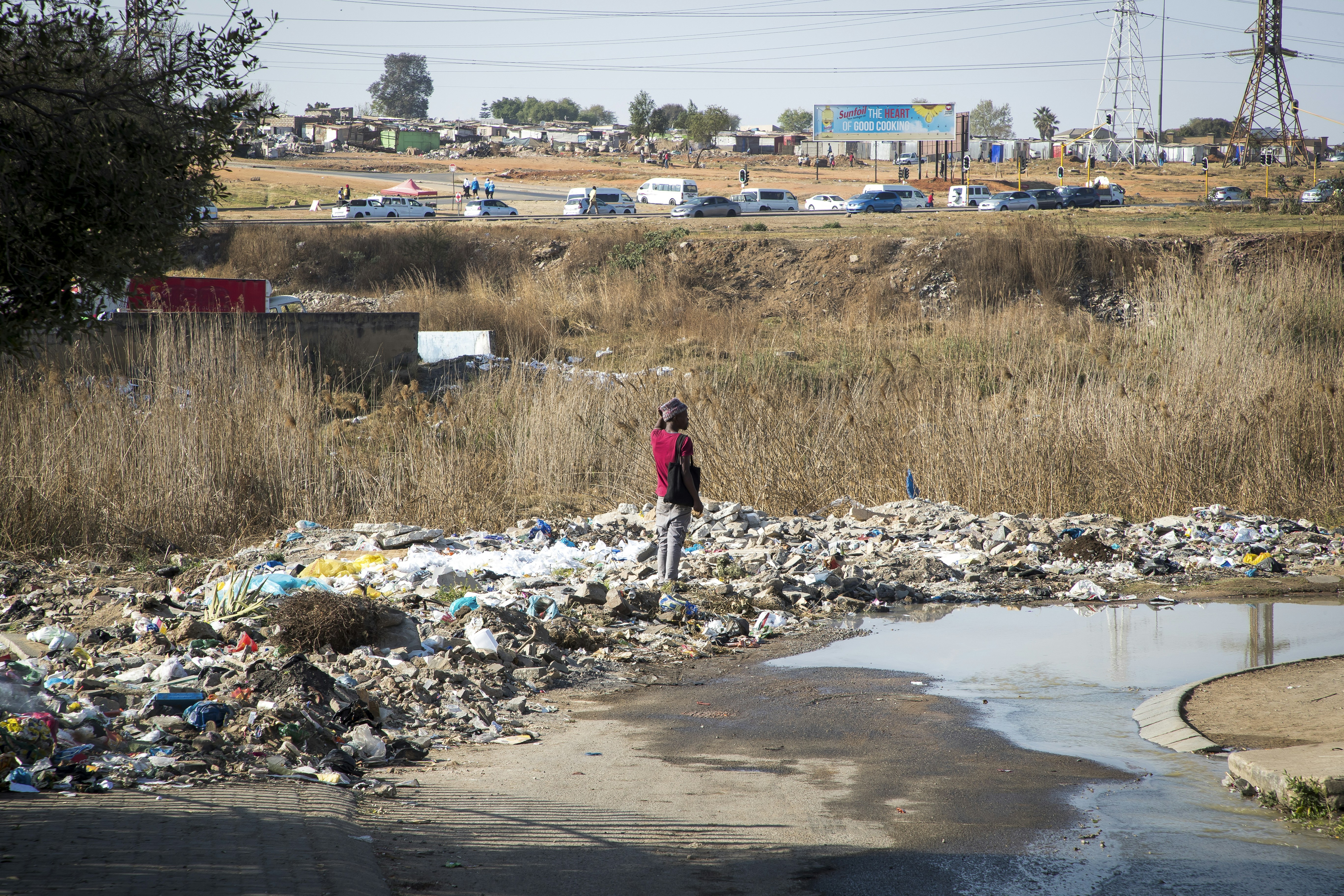 A person standing in a puddle of water photo – Free South africa Image ...