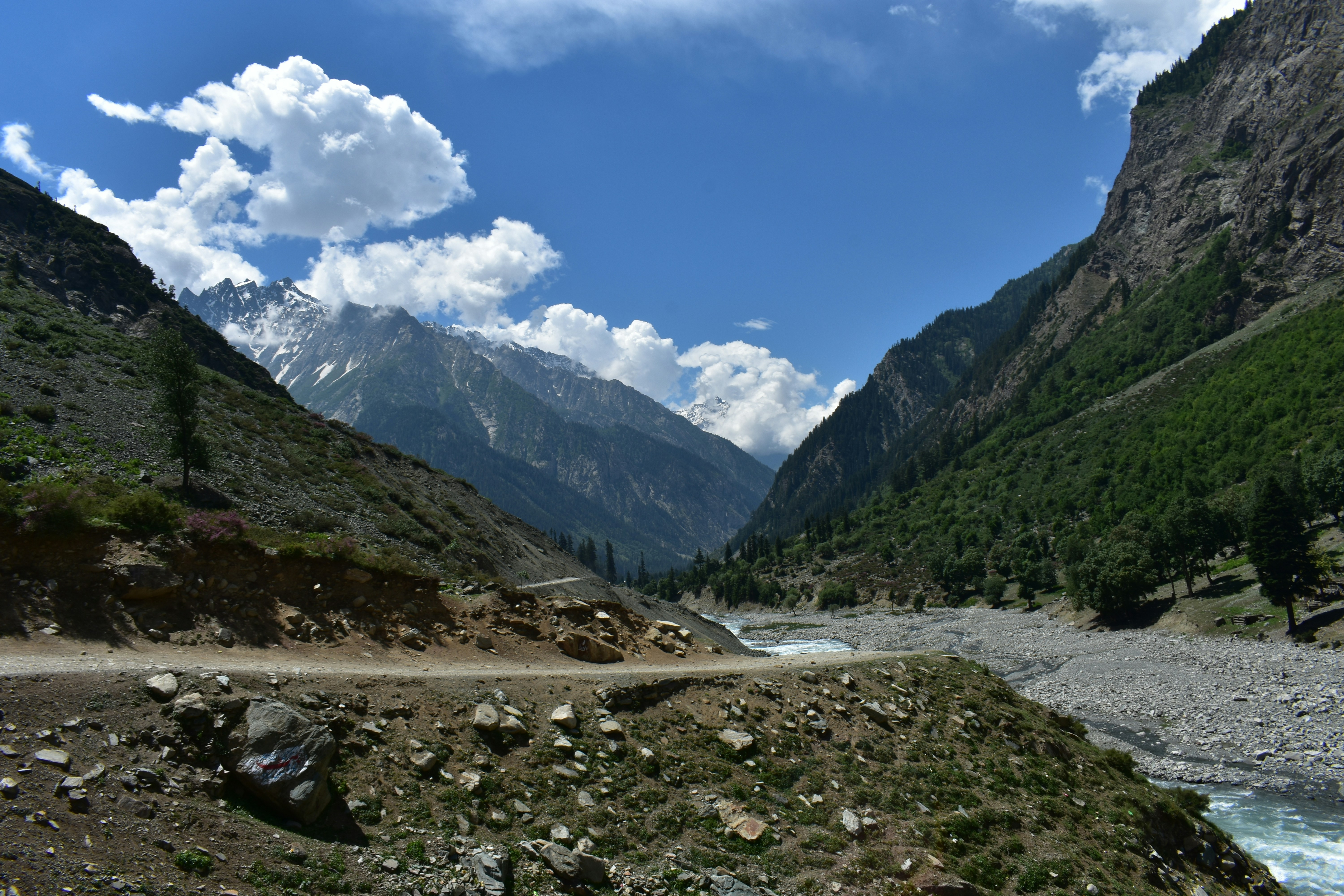 A river running through a valley between mountains photo – Free ...